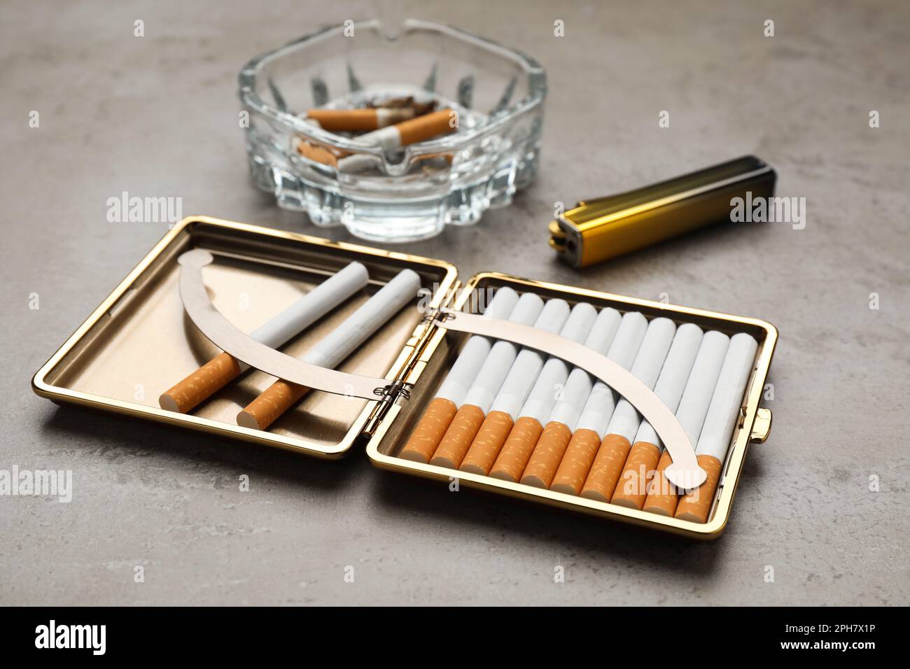 Open case with tobacco filter cigarettes, lighter and glass ashtray on ... Open case with tobacco filter cigarettes, lighter and glass ashtray on ...