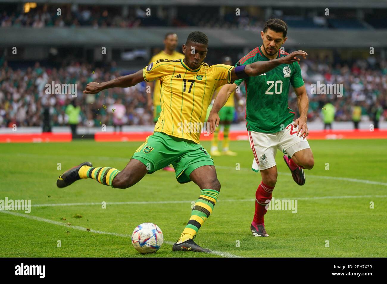 Jamaica's Damion Lowe, left, clears the ball challenged by Mexico's ...