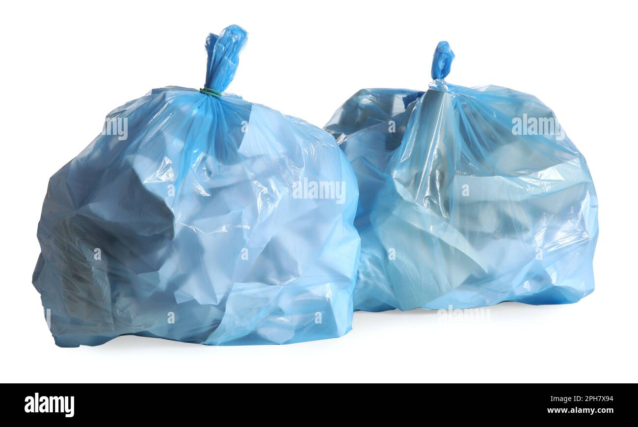 Blue trash bags full of garbage on white background Stock Photo - Alamy