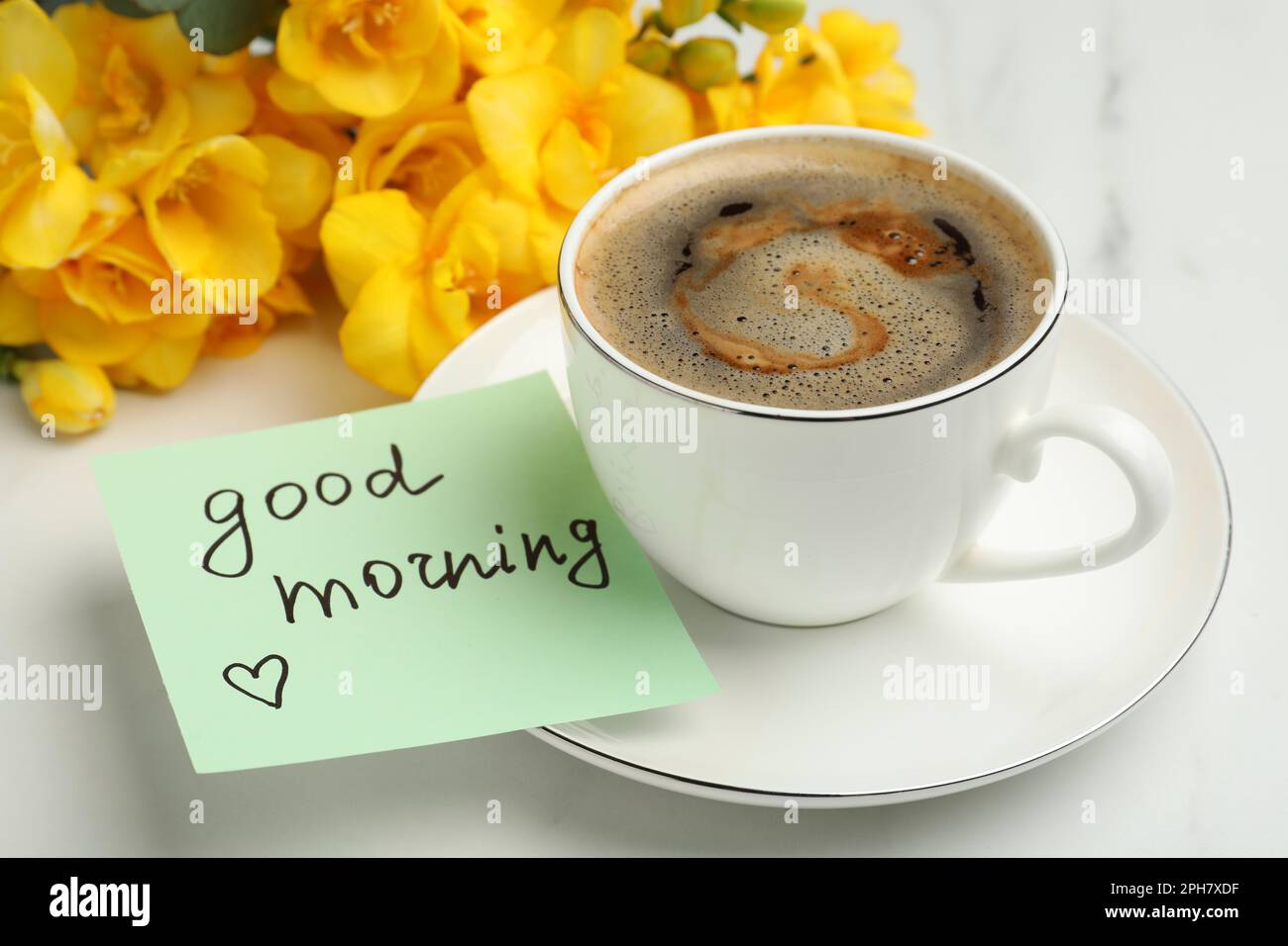 Cup of aromatic coffee, beautiful yellow freesias and Good Morning note ...