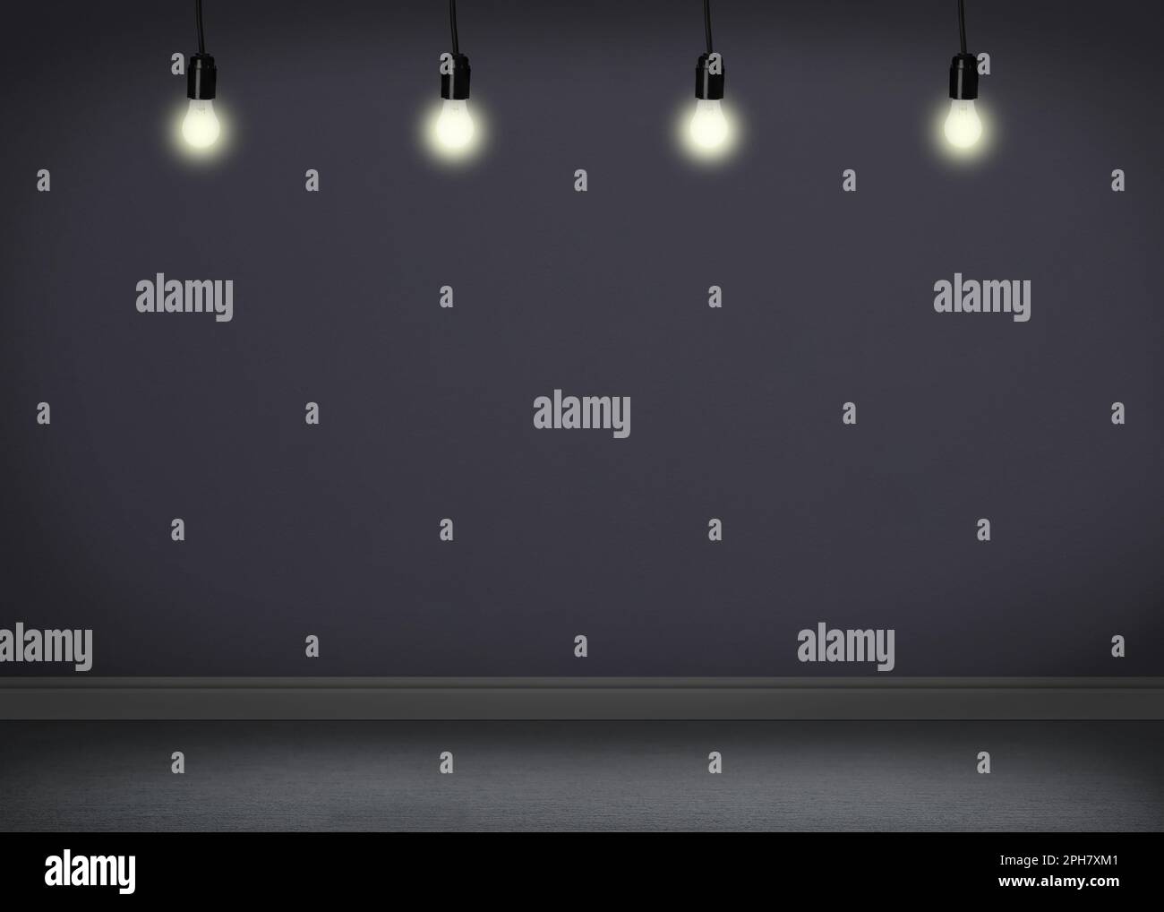 Glowing light bulbs in room with grey wall and room Stock Photo - Alamy