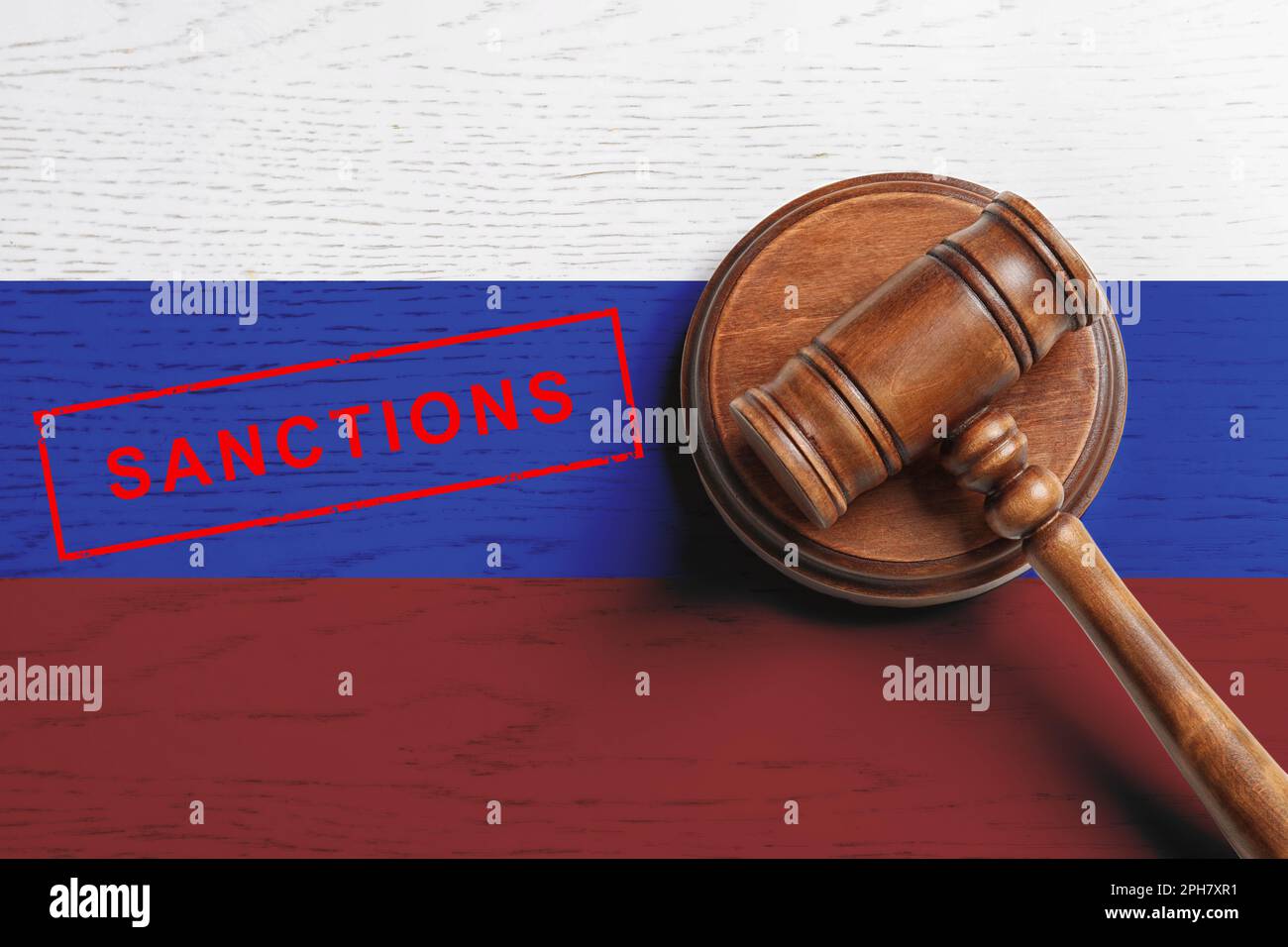 Judge's gavel on wooden background in color of Russian flag, top view ...
