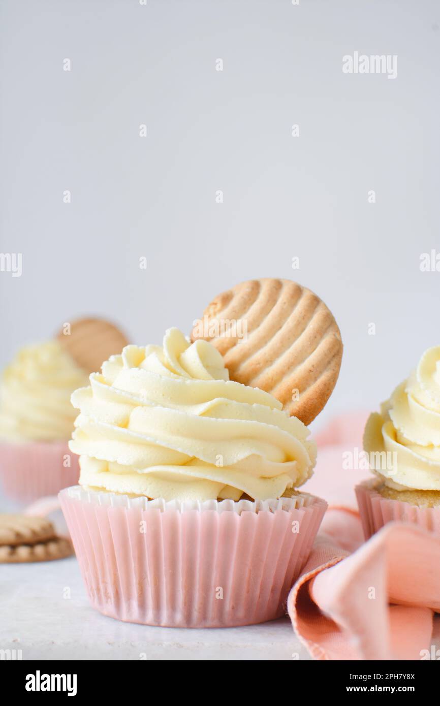Pink cupcakes with tall american buttercream swirl and cookie garnish ...