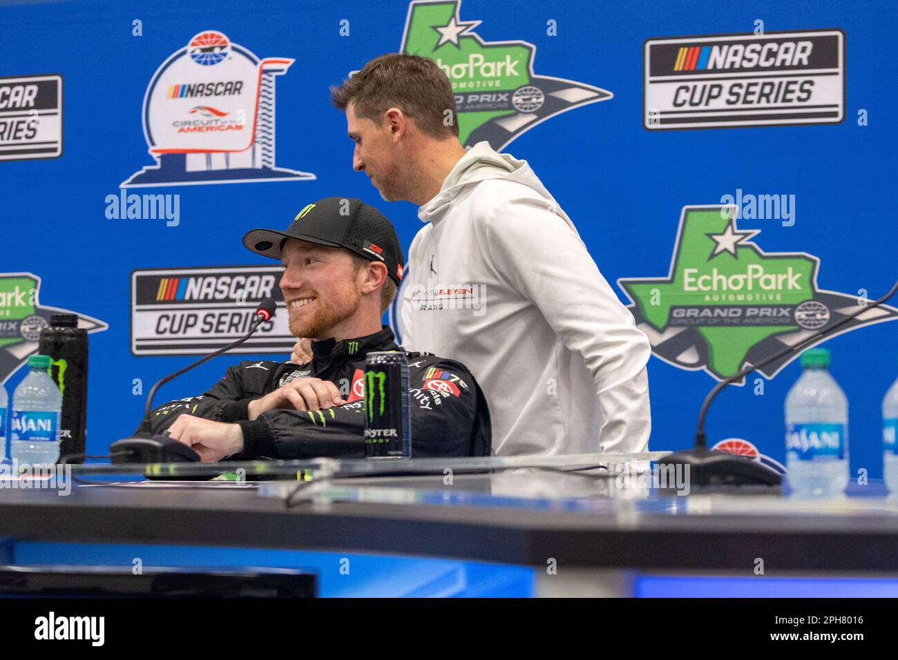 Tyler Reddick, left, and co-owner Denny Hamlin speak after winning a ...