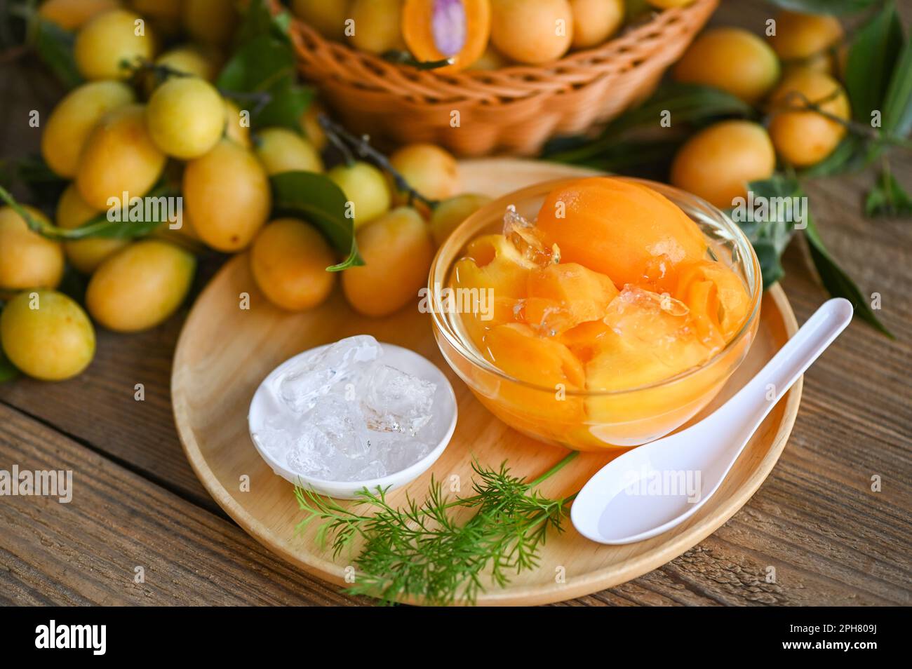 Sweet dessert marian plum fruit on bowl for food and wooden background ...