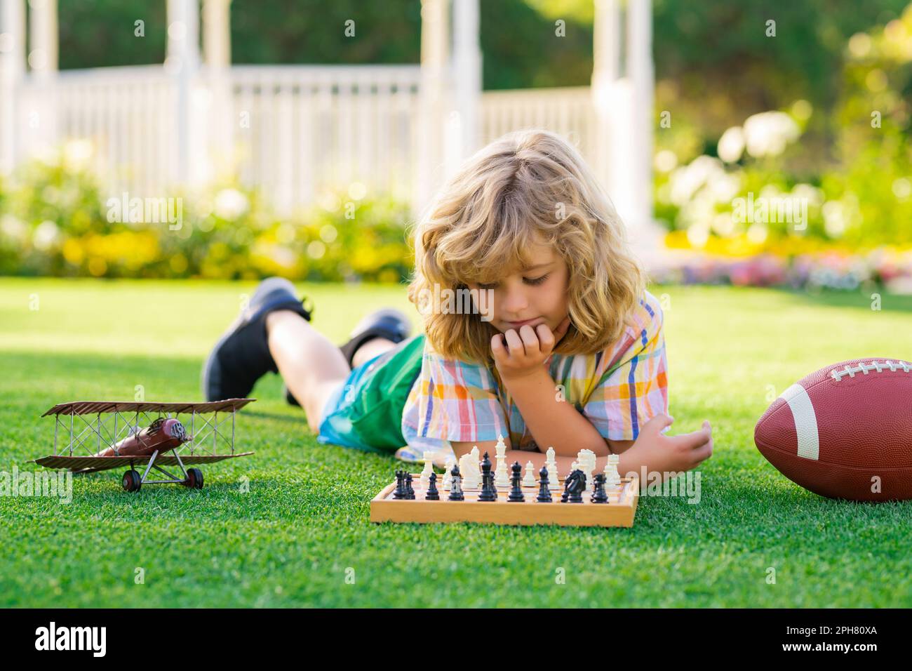 Little kid chessman play chess game, checkmate. Child playing chess in ...
