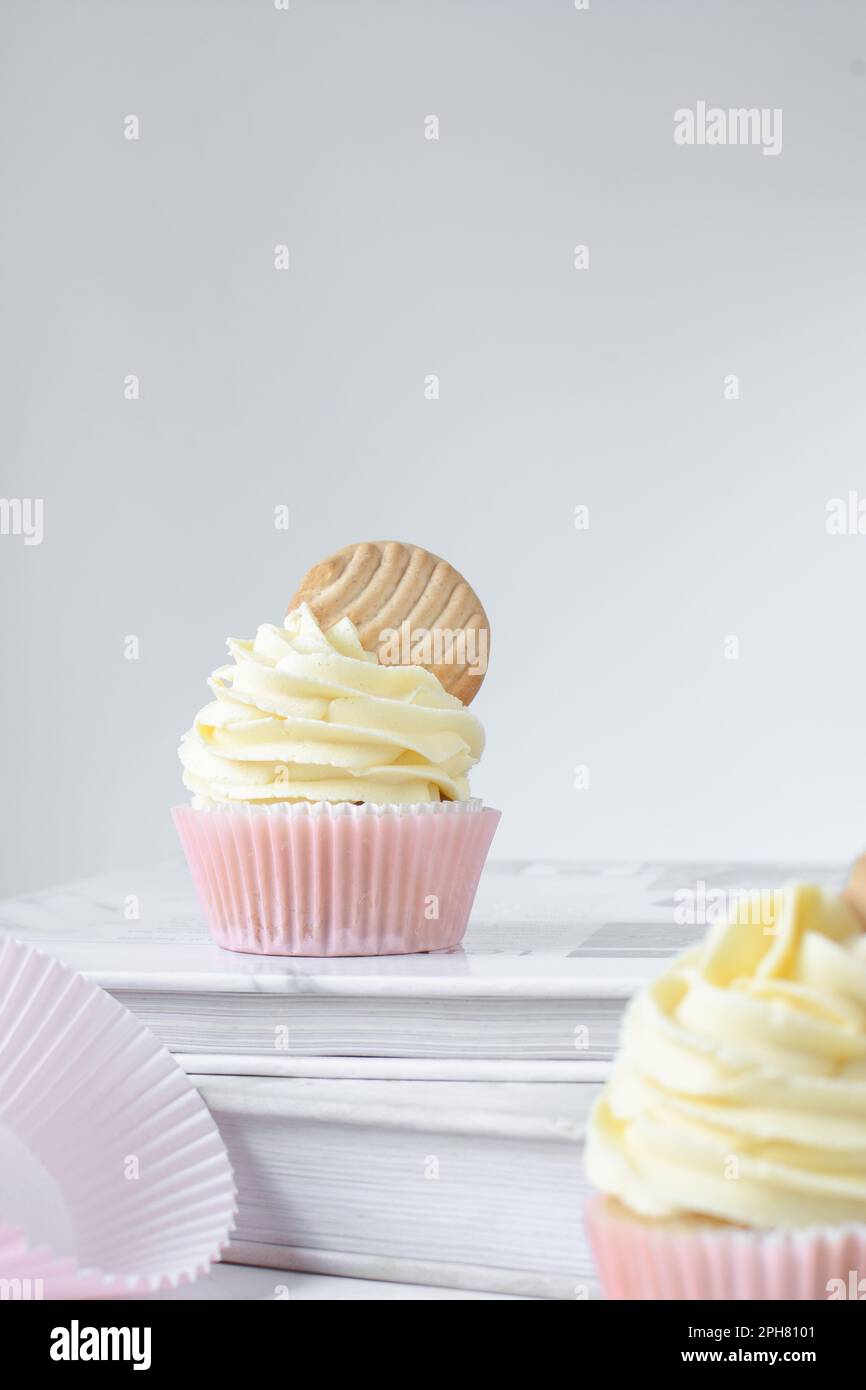 Pink cupcakes with tall american buttercream swirl and cookie garnish ...
