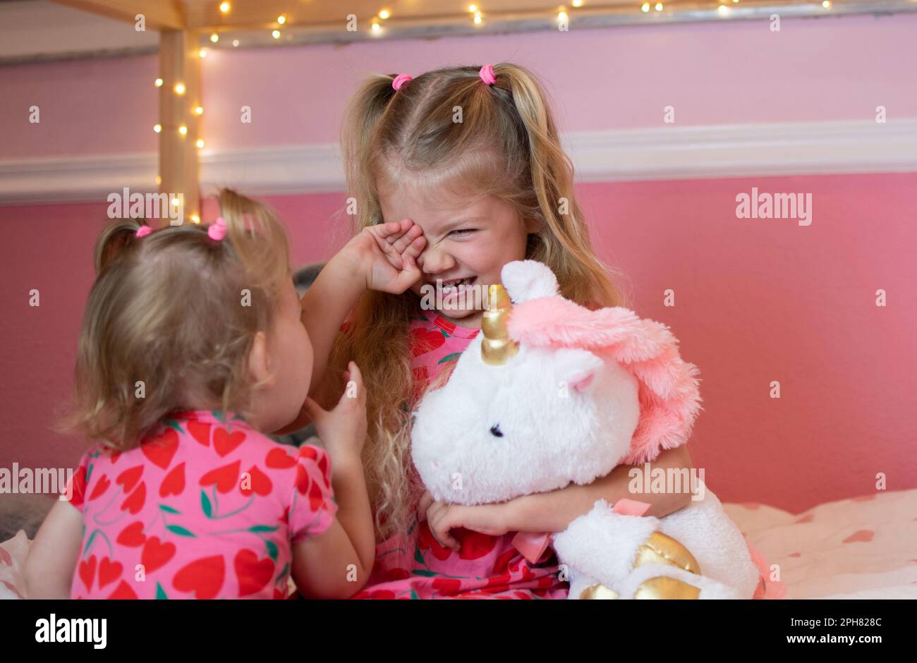 Crying little girl with her sister. Sibling's love and relationship ...