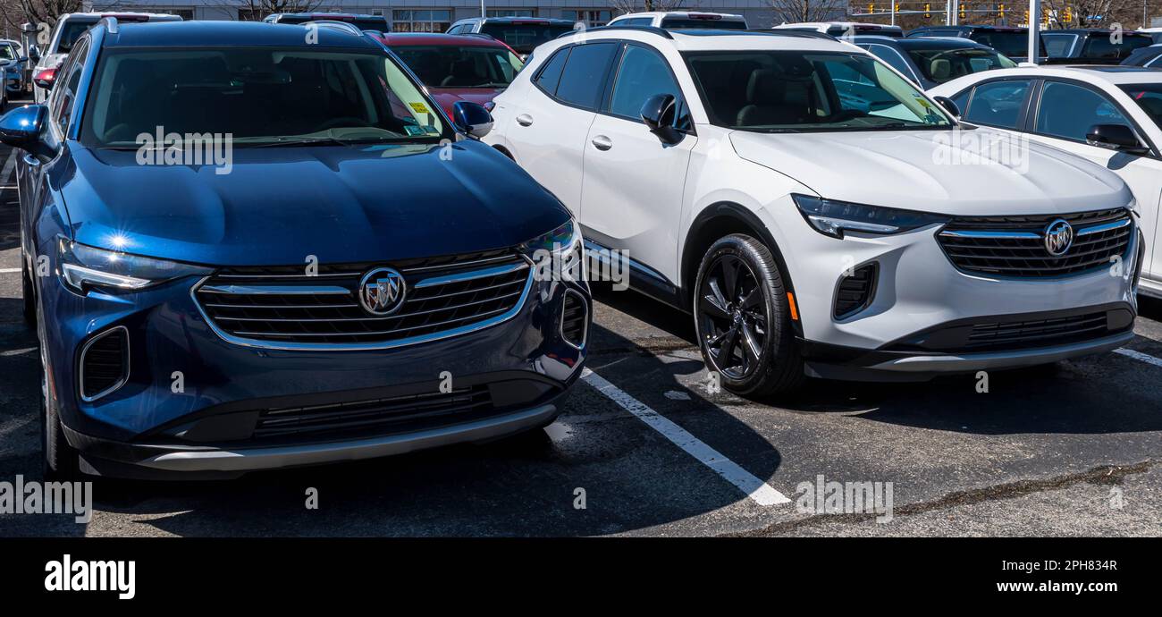 Two used Buick SUVs, a blue and a white one for sale at a dealership in ...