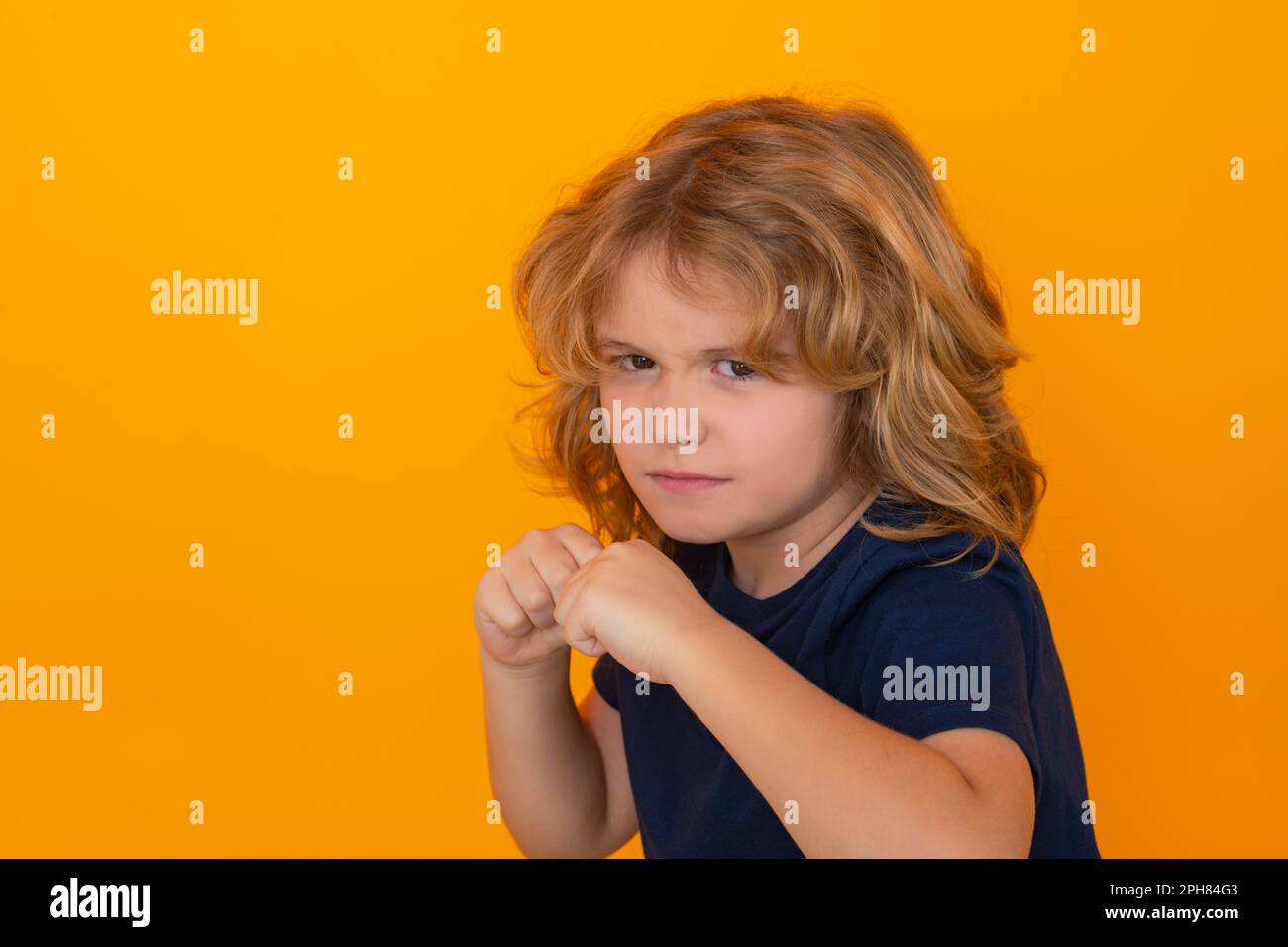 Angry child with fist gesture fight, hit on studio isolated background ...