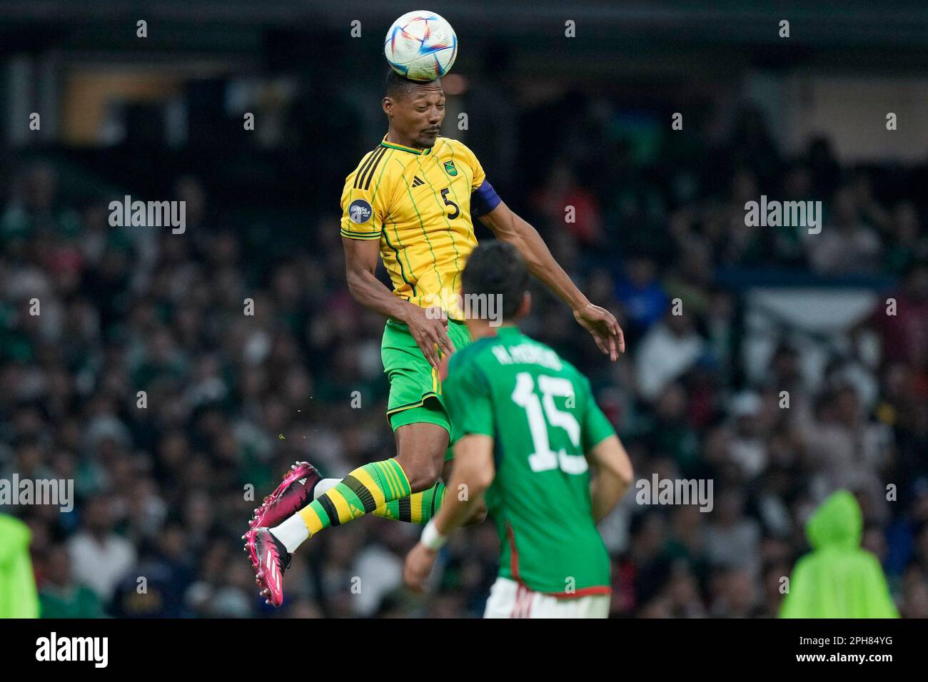 Jamaica's Ethan Pinnock, top, heads the ball in front of Mexico's ...
