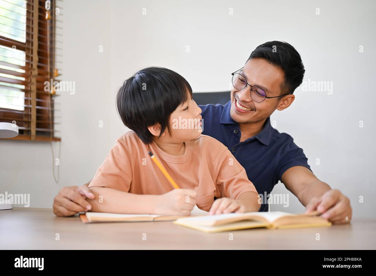 Confused and curious young little son asking a question while his dad ...
