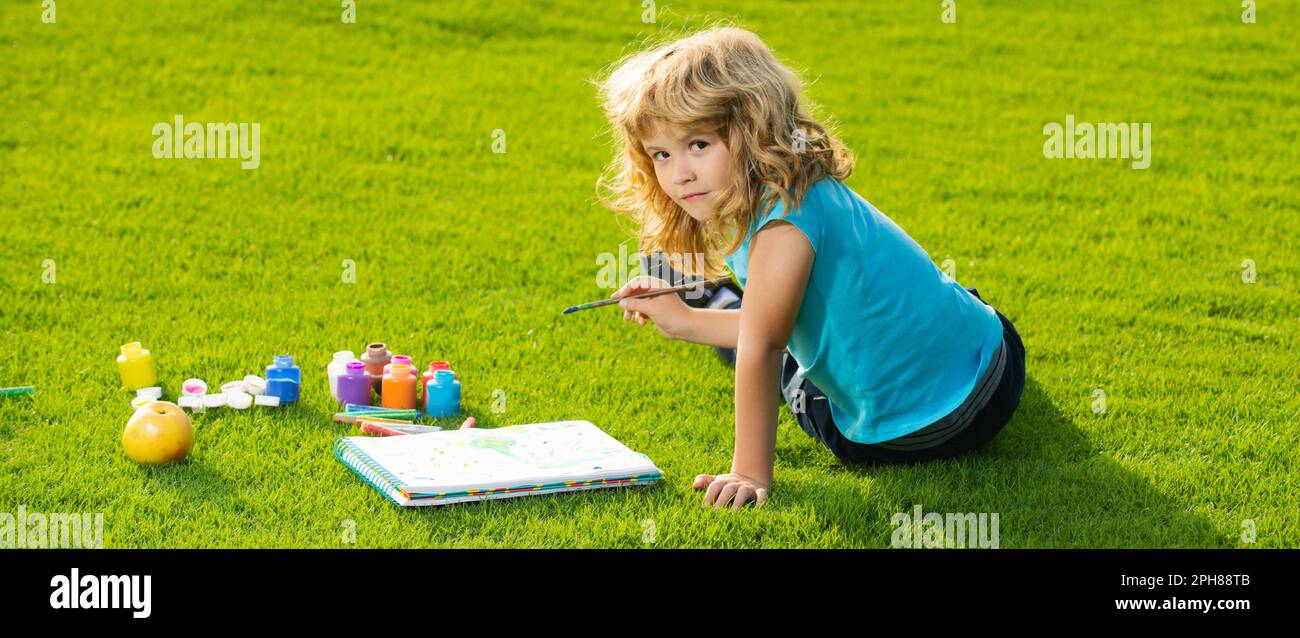 Portrait of smiling happy kid enjoying art and craft drawing in ...