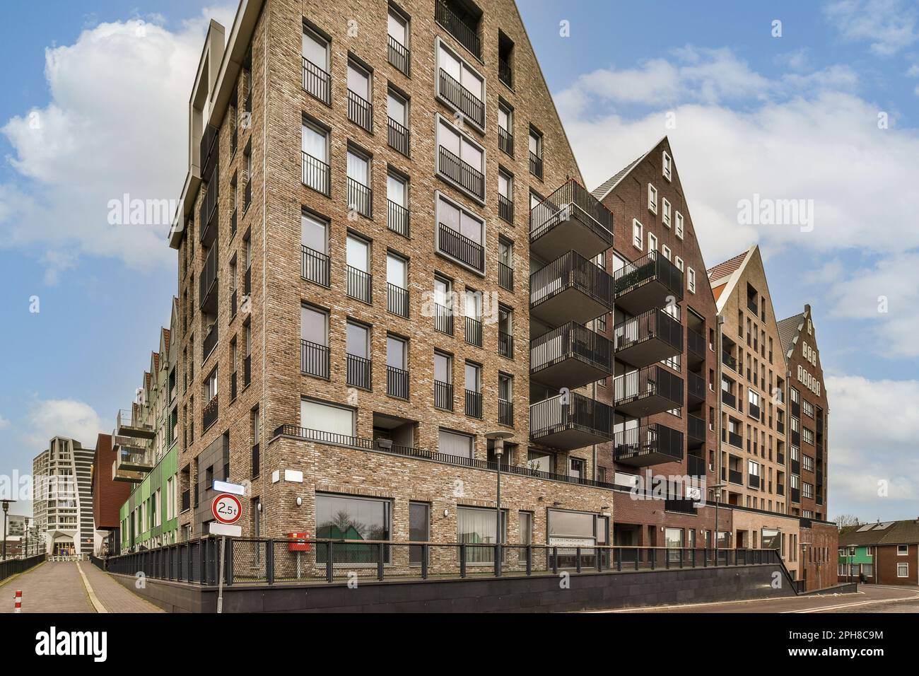 an apartment building on the side of a street with a stop sign in front ...