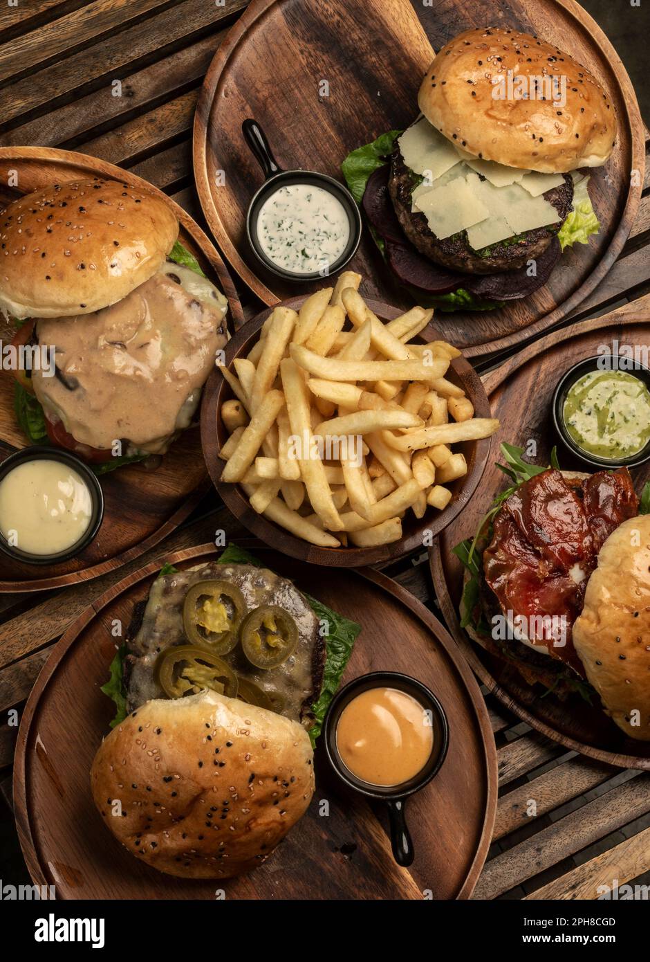 many different gourmet burgers selection on restaurant wood table Stock ...