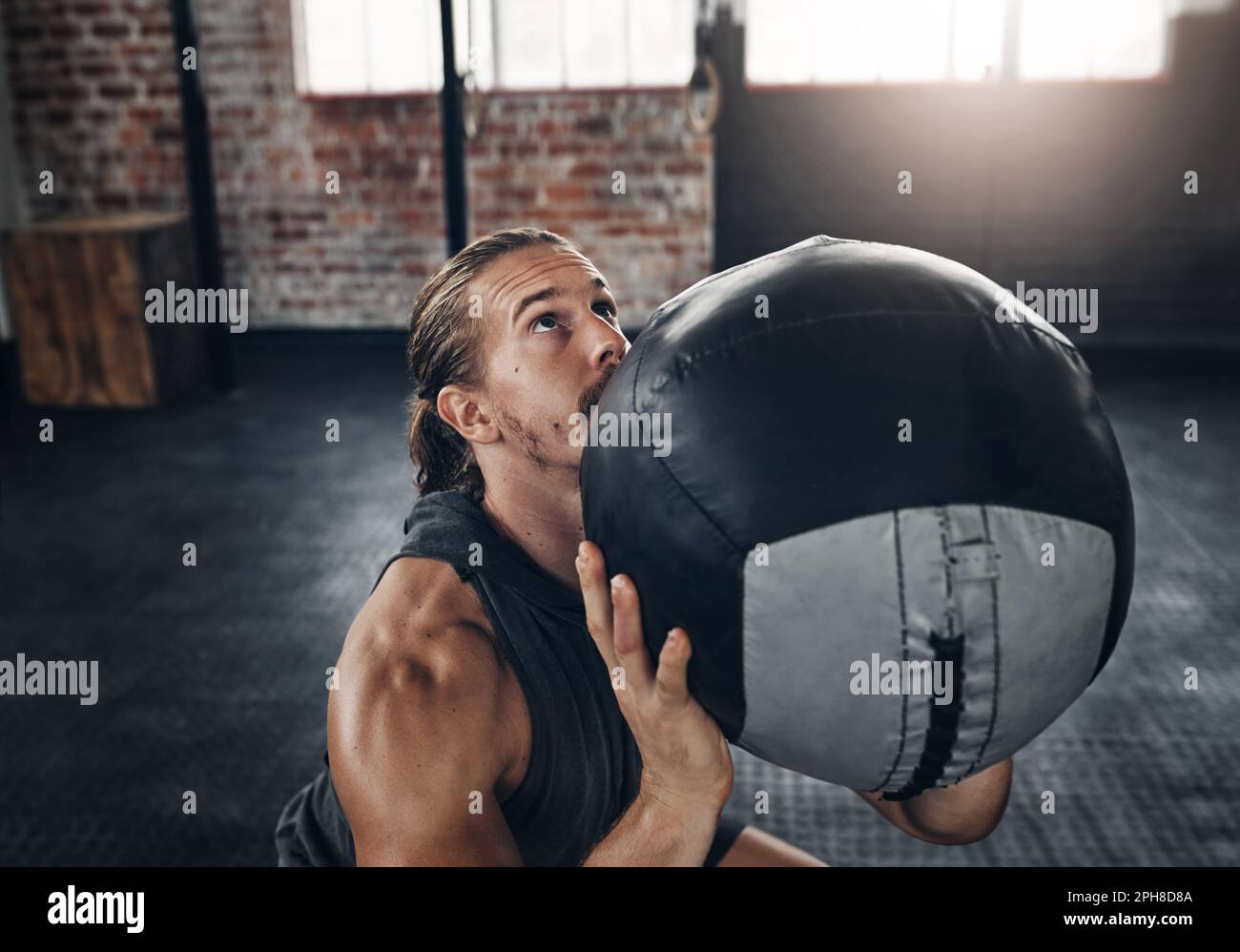 Switch up your routine by using different equipment. a muscular young ...
