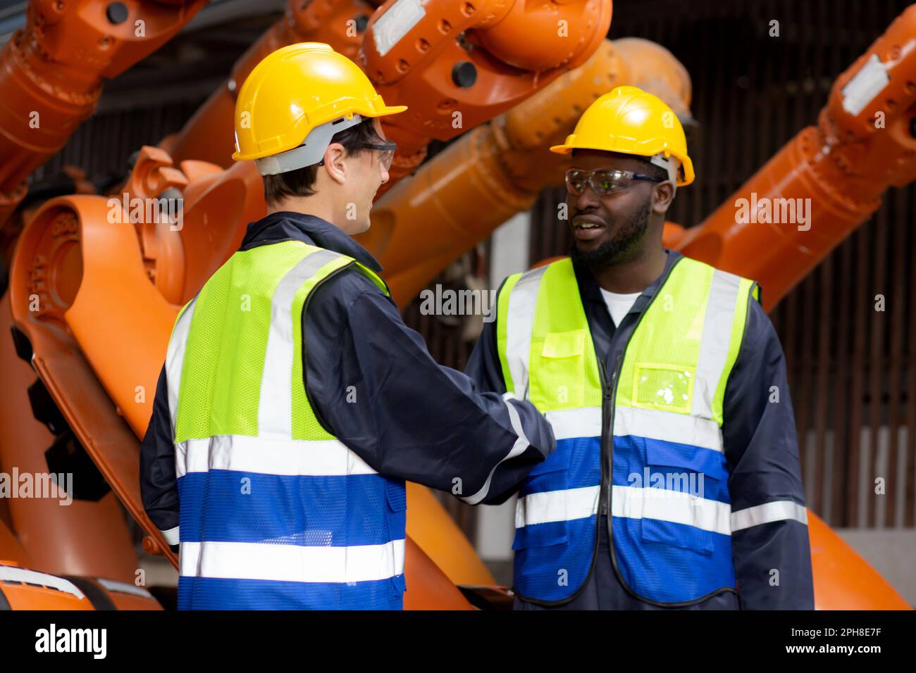 Two young engineer man handshake with partner for agreement while ...