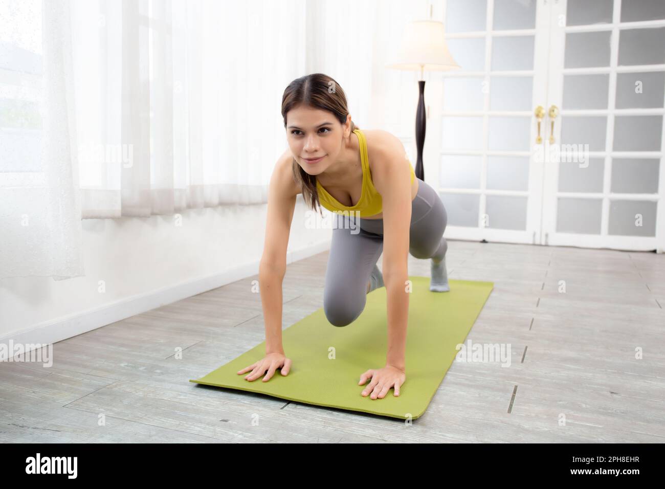 Beautiful young caucasian woman practicing workout exercise with plank ...