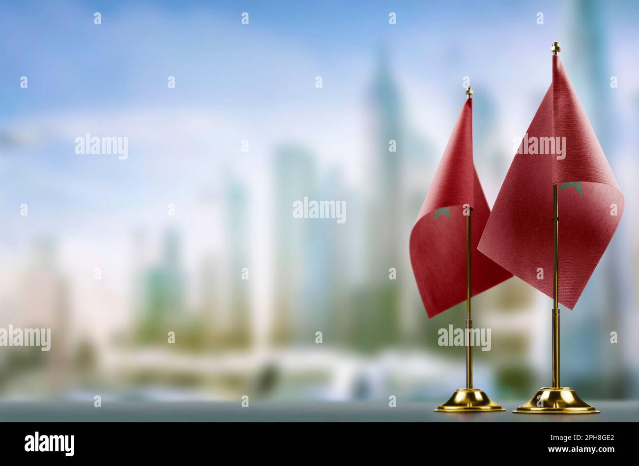 Small flags of the Morocco on an abstract blurry background Stock Photo ...