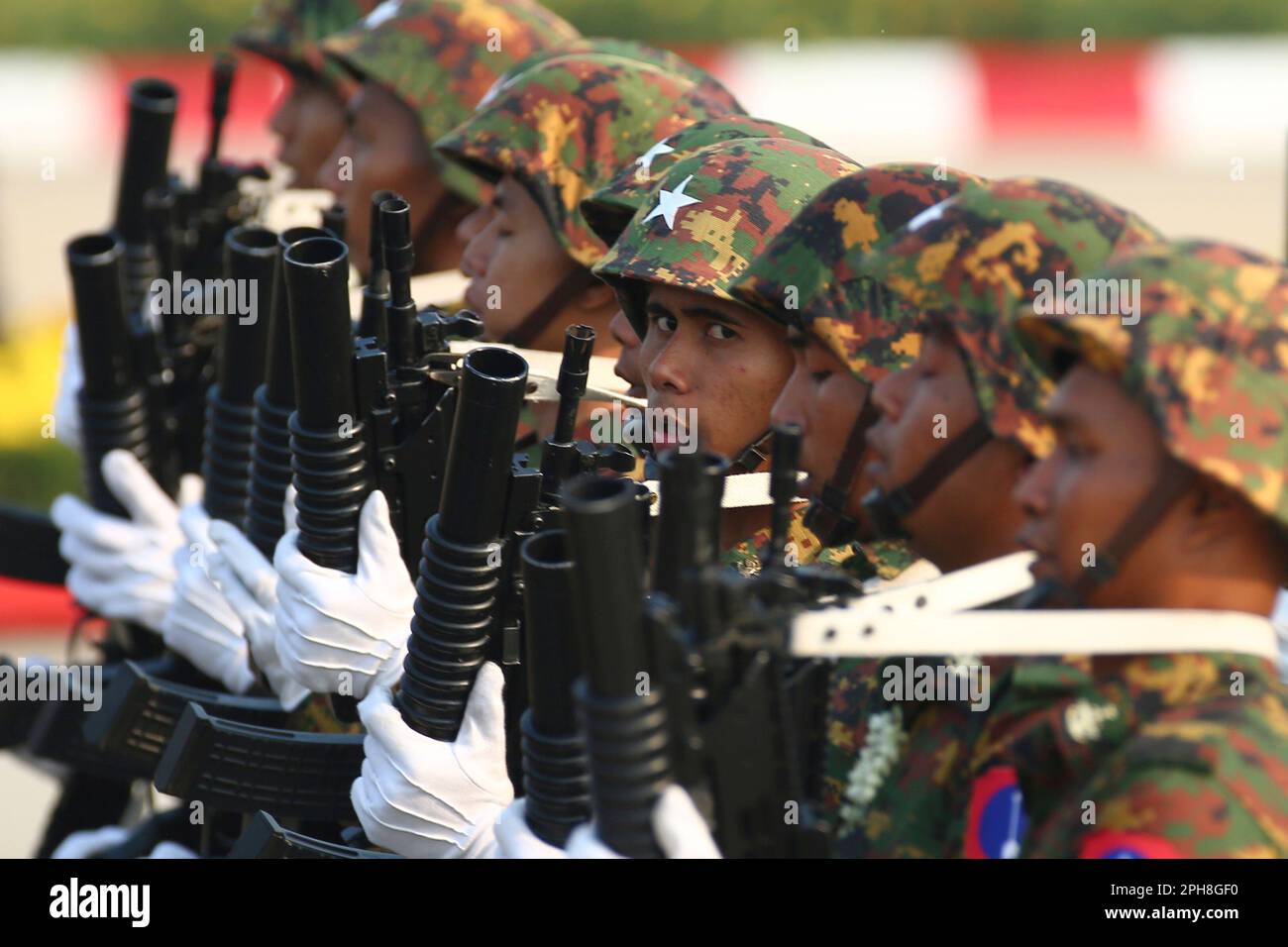 Military officers march during a parade to commemorate Myanmar's 78th ...