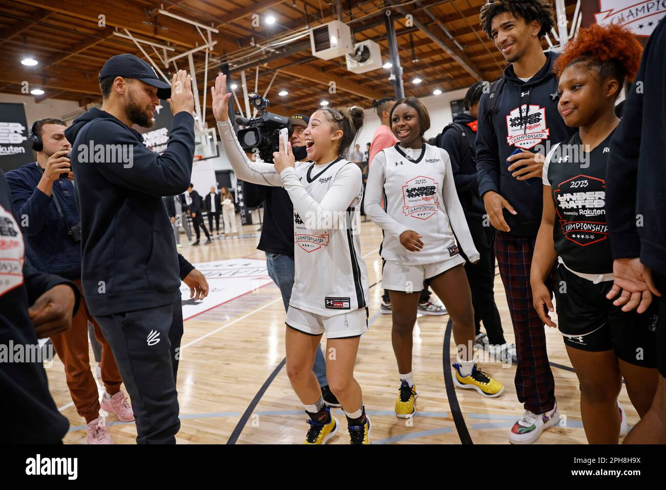 Jada Travis high-fives Golden State Warriors guard Stephen Curry as he ...
