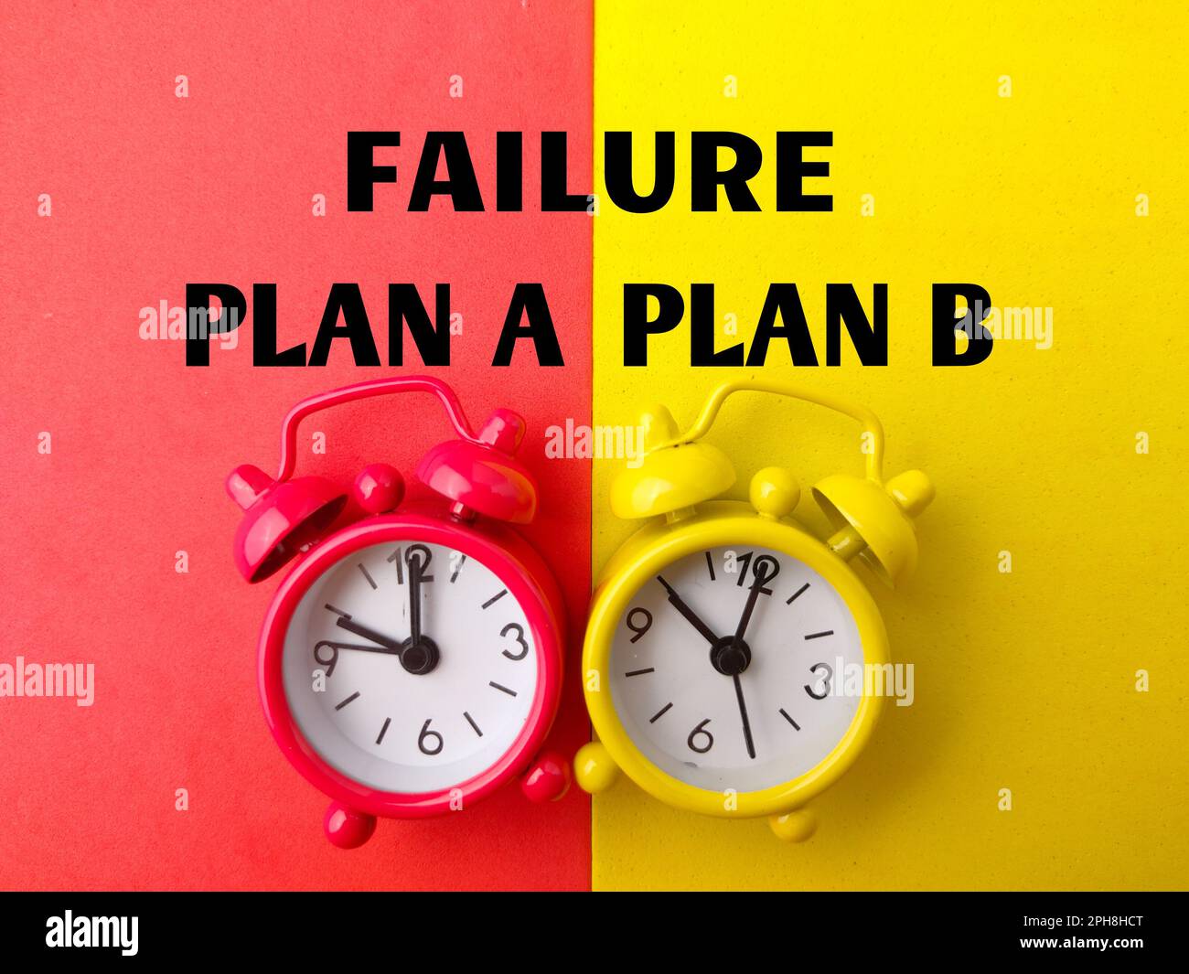 Colored alarm clock with the word FAILURE PLAN A and B. Business ...