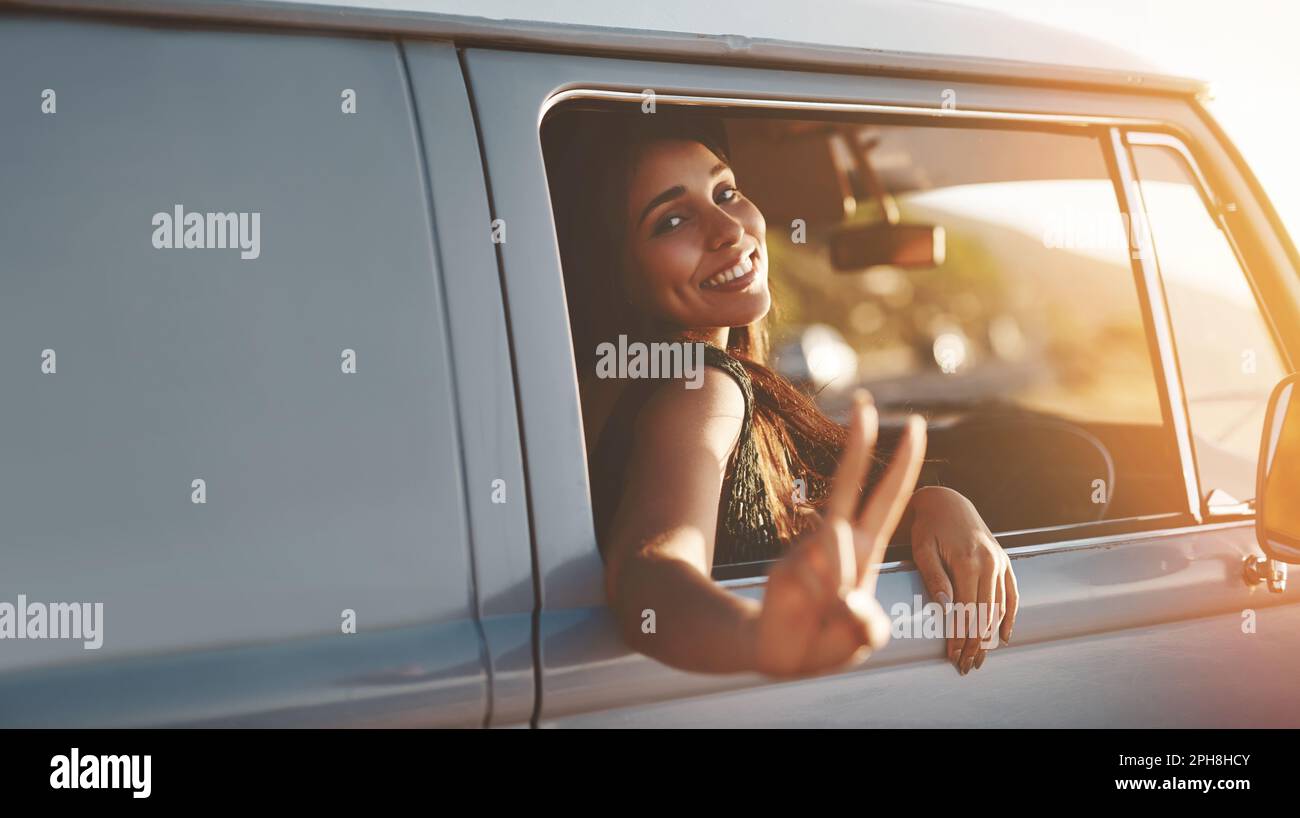 Im off to live my life. a young woman leaning out of a vans window and ...