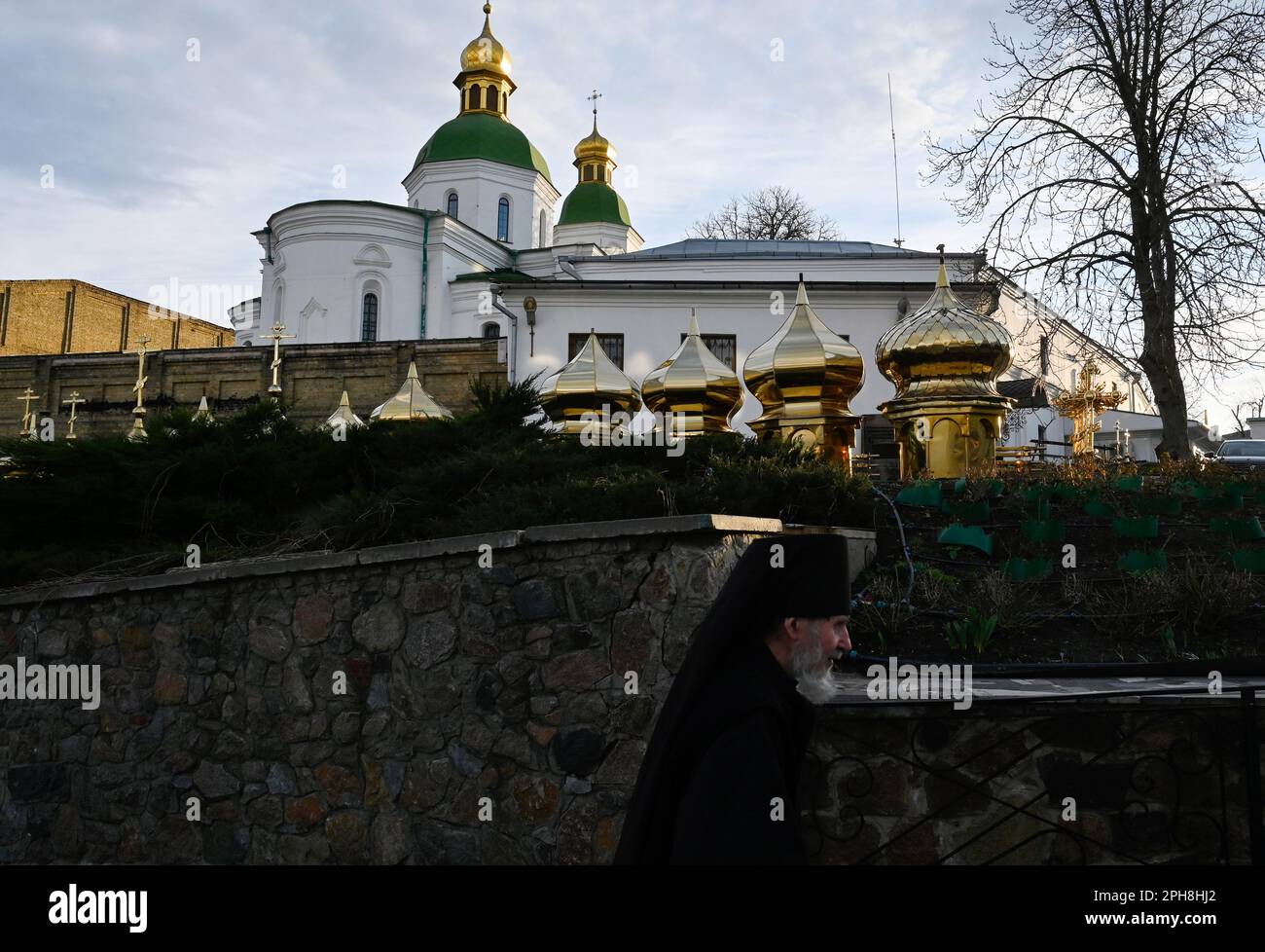An Orthodox priest walks in Kyiv-Pechersk Lavra in Kyiv, amid the ...