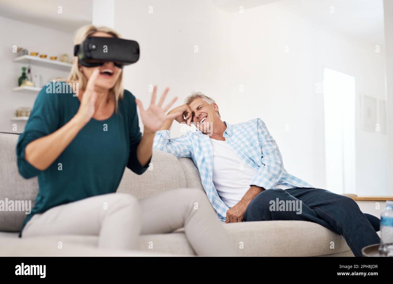 Its so realistic. a mature woman using a VR headset with her husband in ...