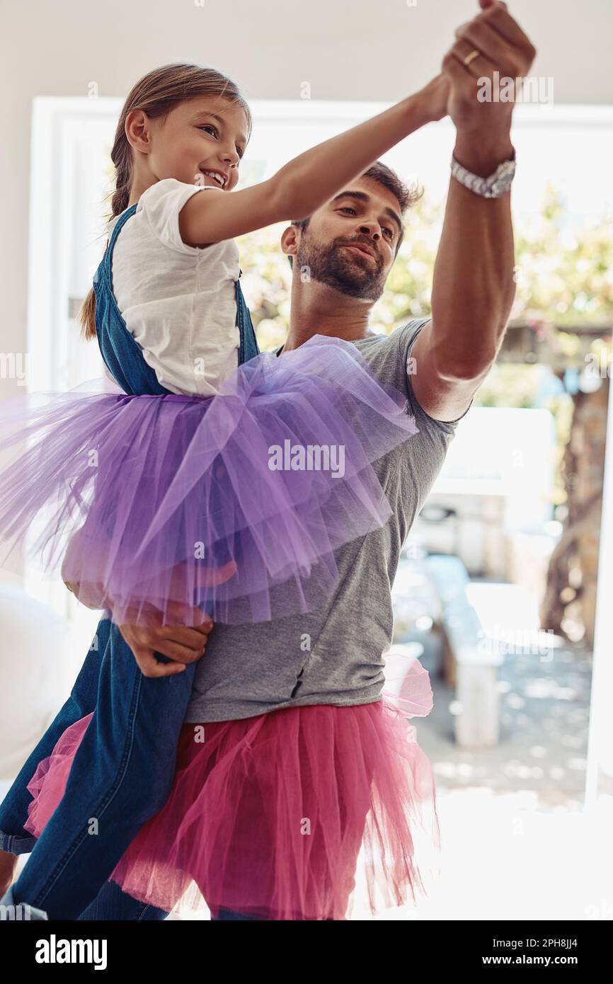 Being the best dad he can be for her. a father and daughter dancing in ...