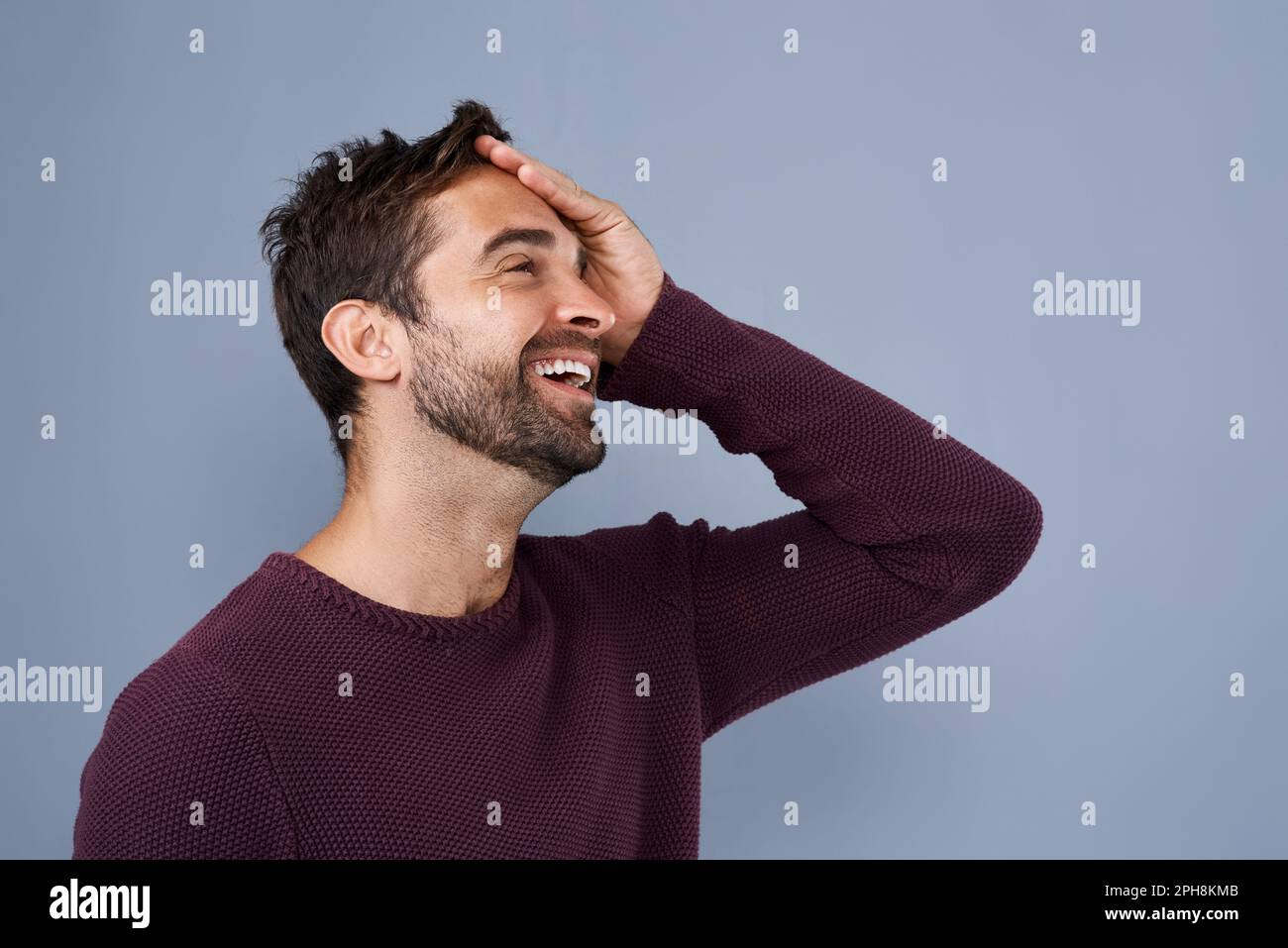 Dodged a bullet. Studio shot of a handsome young man looking relieved ...