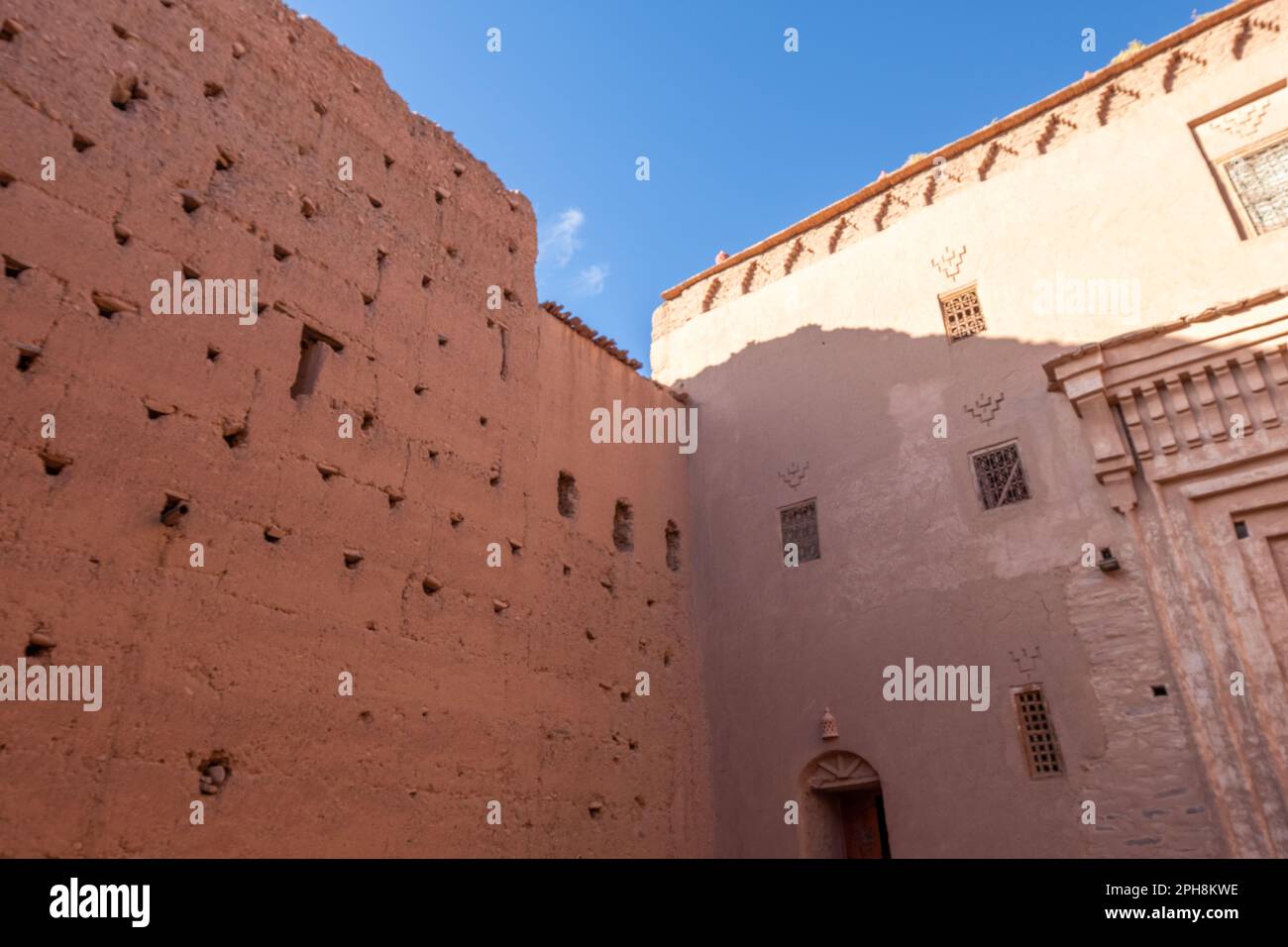 The immense walls of a kasbah of a semi-desert barbarian village in the ...