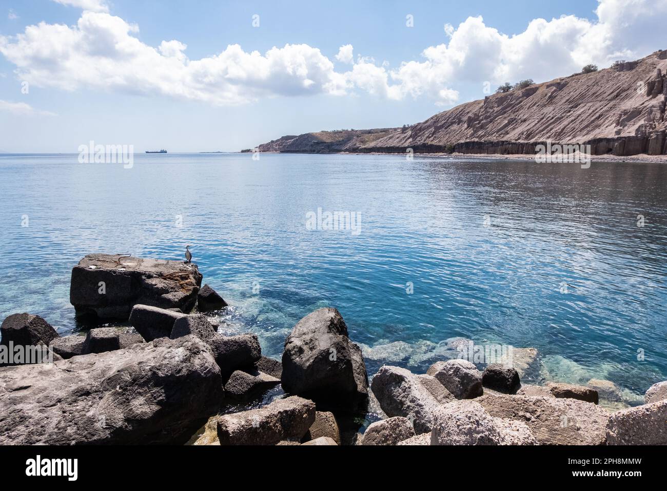 The calm blue sea of greece in santorini island seen from behind black ...