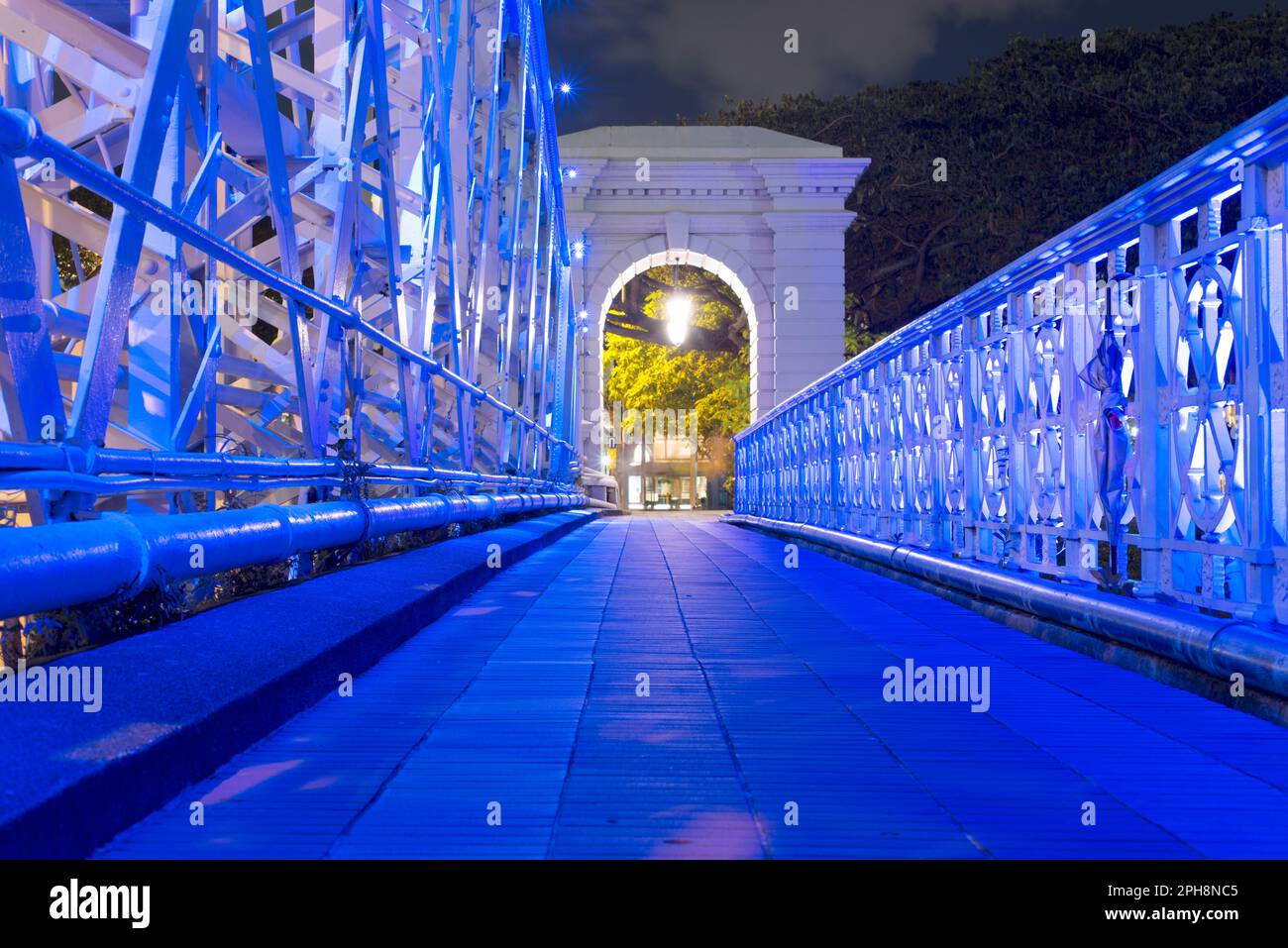 night pedestrian bridge pathway illuminated by blue light in Singapore ...