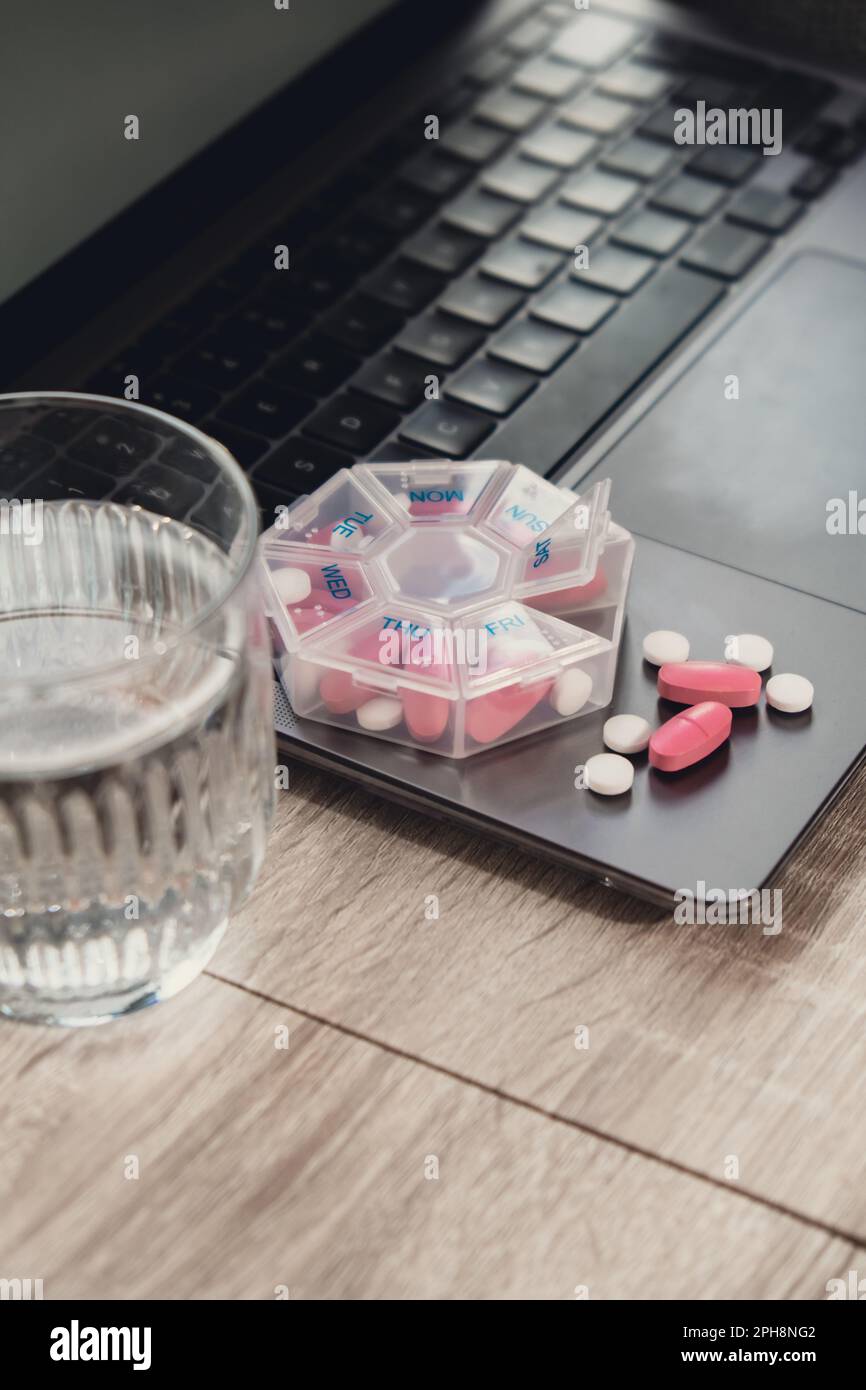 Organizer weekly shots with glass of water on workplace background and ...