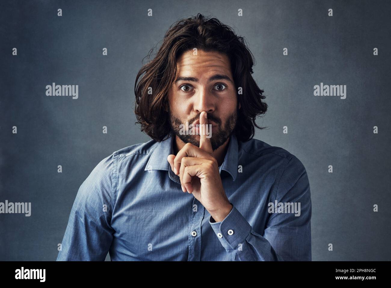 This is our little secret. Studio portrait of a handsome young man ...