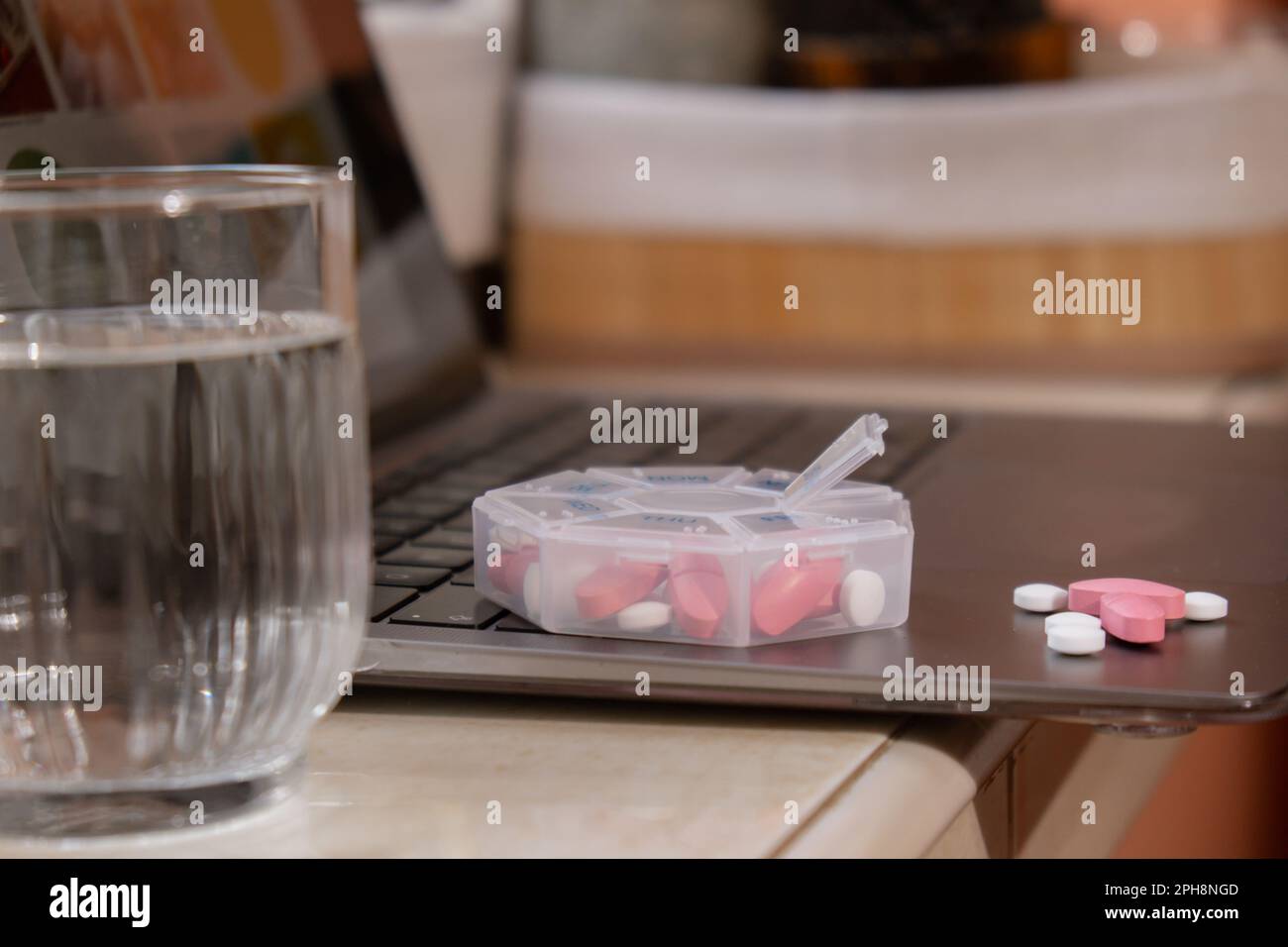 Organizer weekly shots with glass of water on workplace background and ...