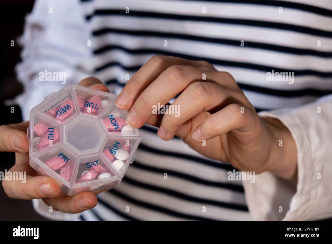 Woman sorting pills Organizer weekly shots Closeup of medical pill box ...