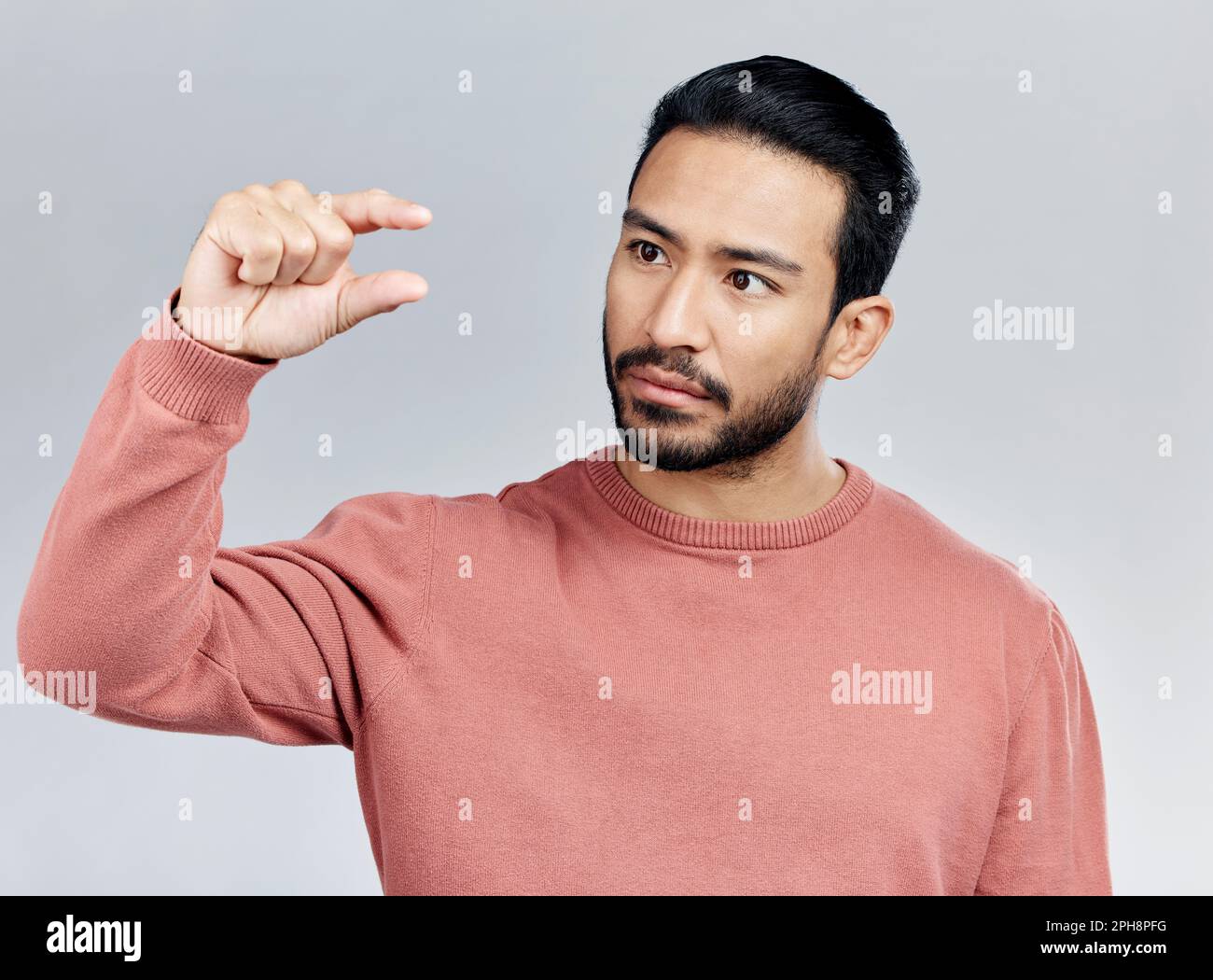 Little, small sign and hand of man in studio on white background to ...