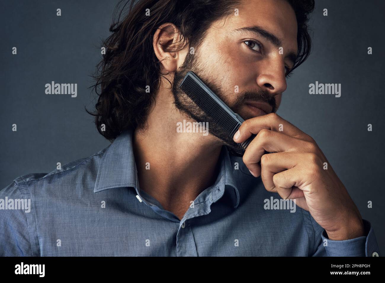 The power of beards is undeniable. Studio shot of a handsome young man ...