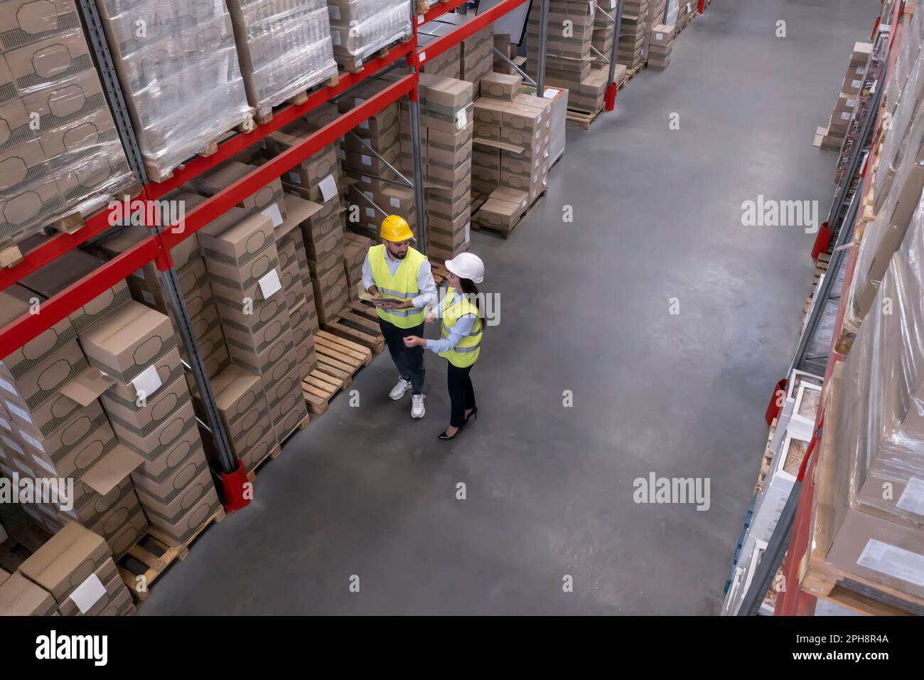 Manager and worker at warehouse, above view. Logistics center Stock ...