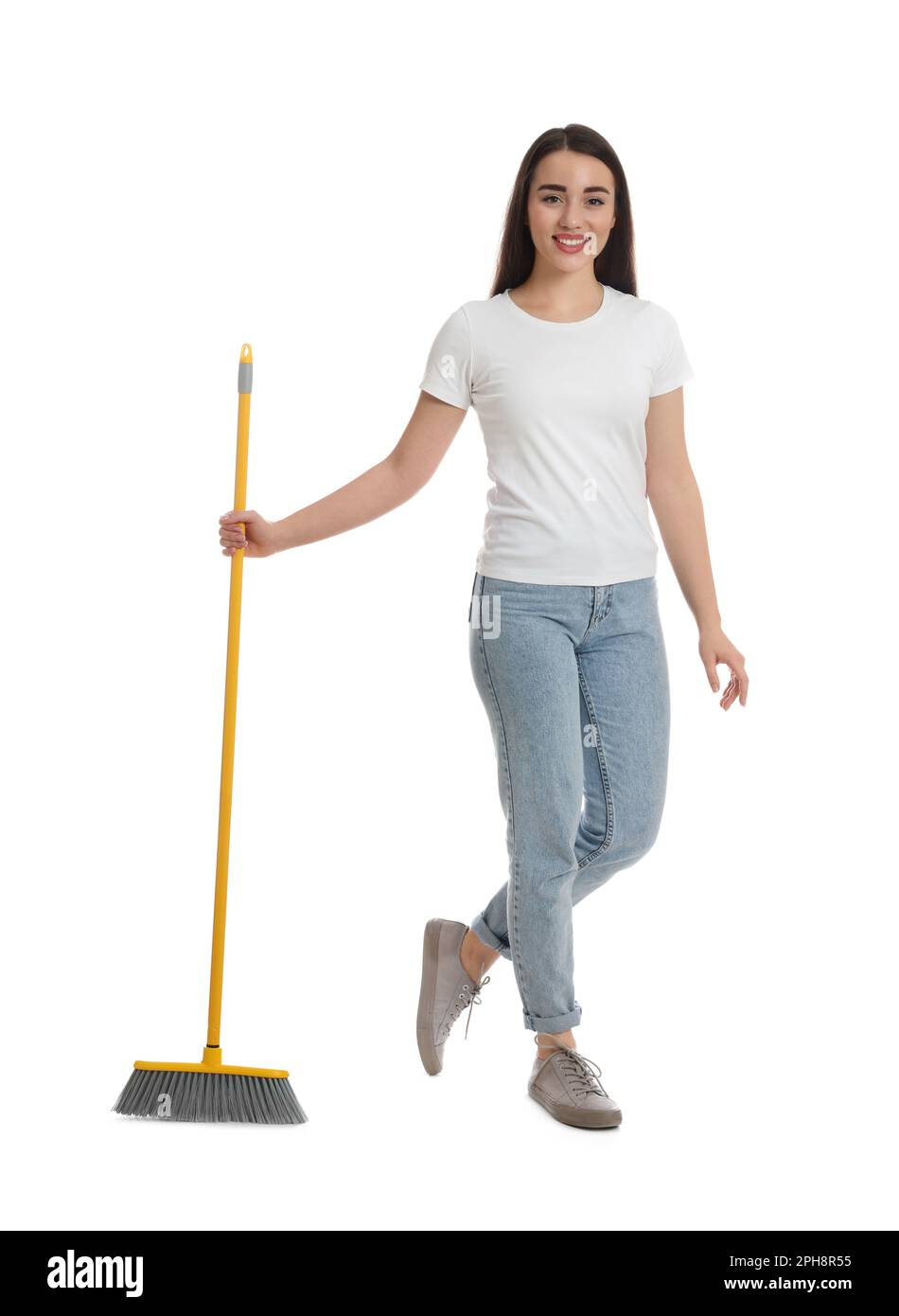Beautiful young woman with broom on white background Stock Photo - Alamy