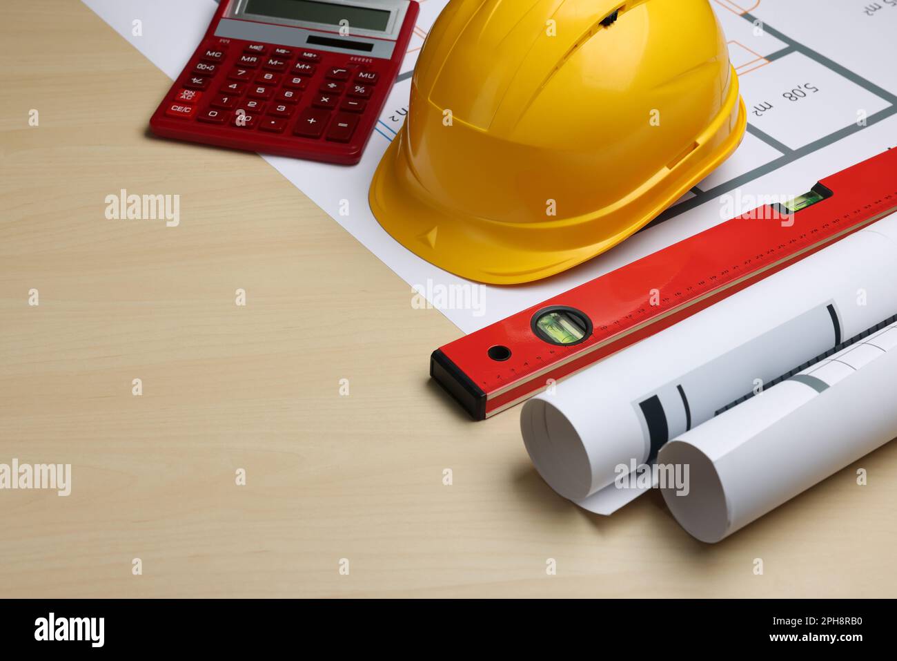 Construction drawings, safety hat, calculator and bubble level on ...