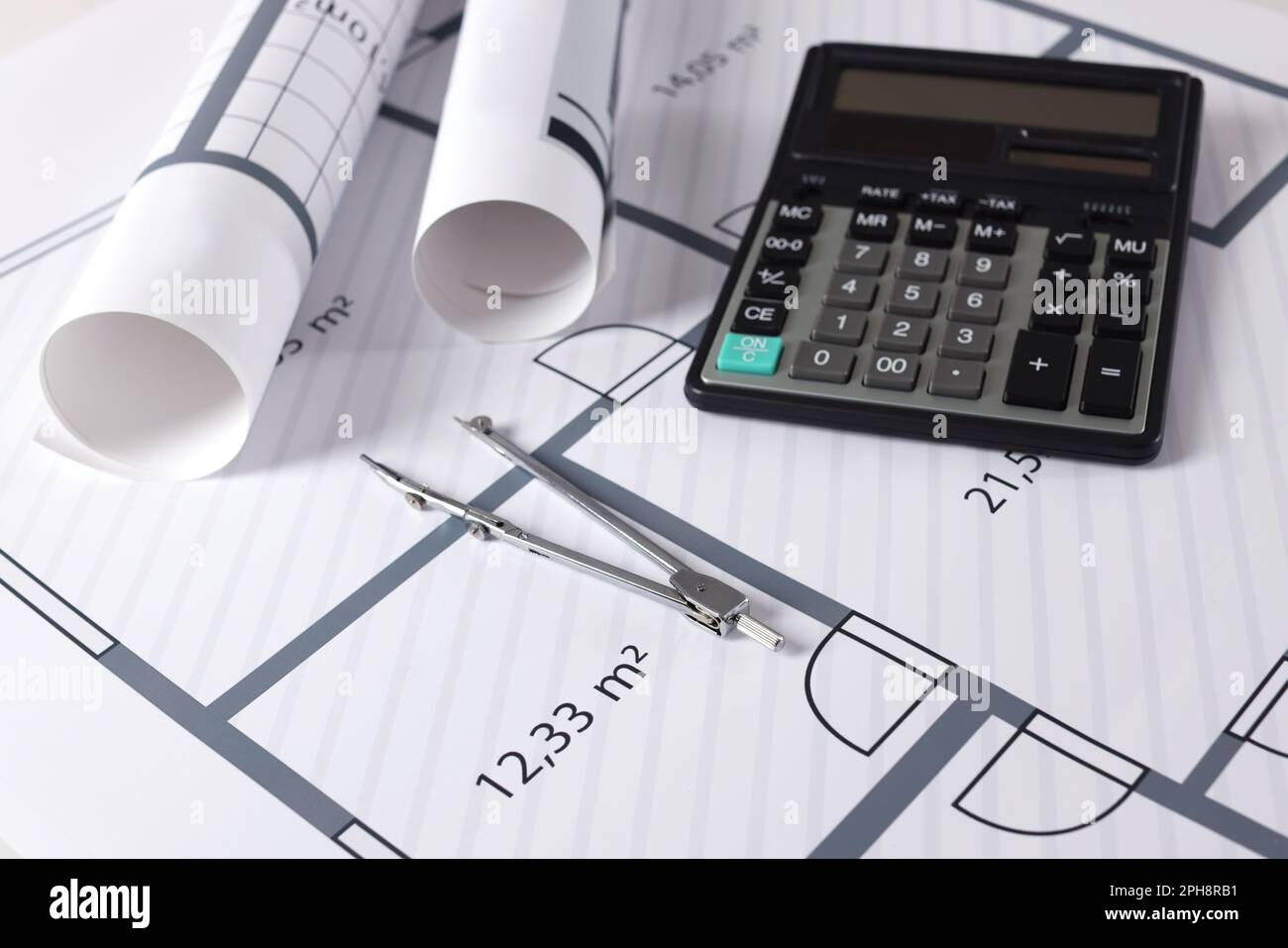 Construction drawings, calculator and dividers, closeup view Stock ...