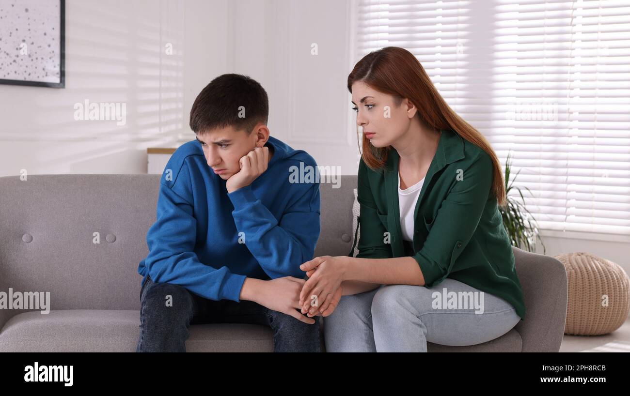 Mother consoling her depressed son at home. Teenager problems Stock ...