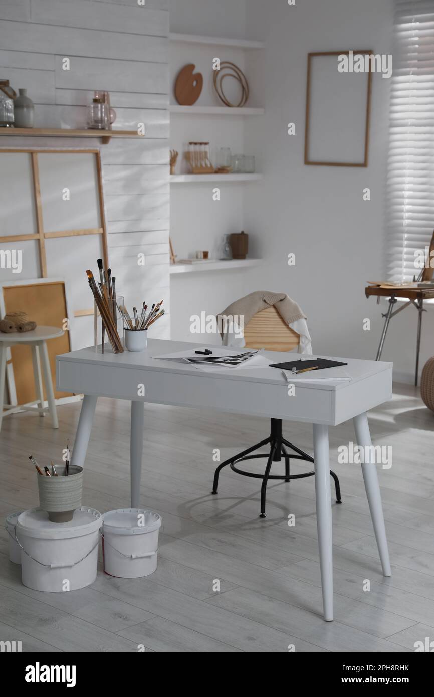 Modern studio interior with artist's workplace and art supplies Stock ...
