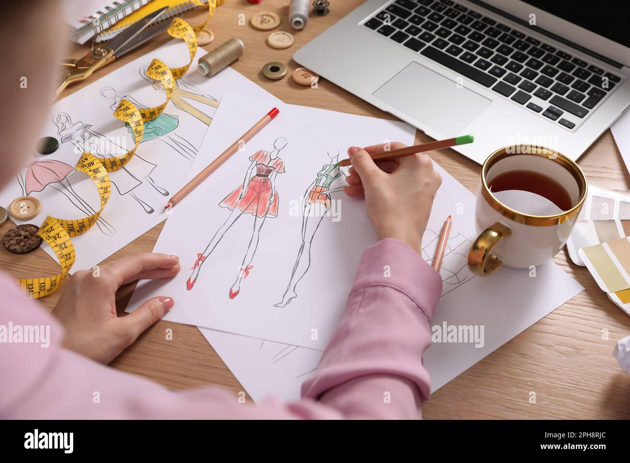 Fashion designer drawing sketch at wooden table, closeup Stock Photo ...