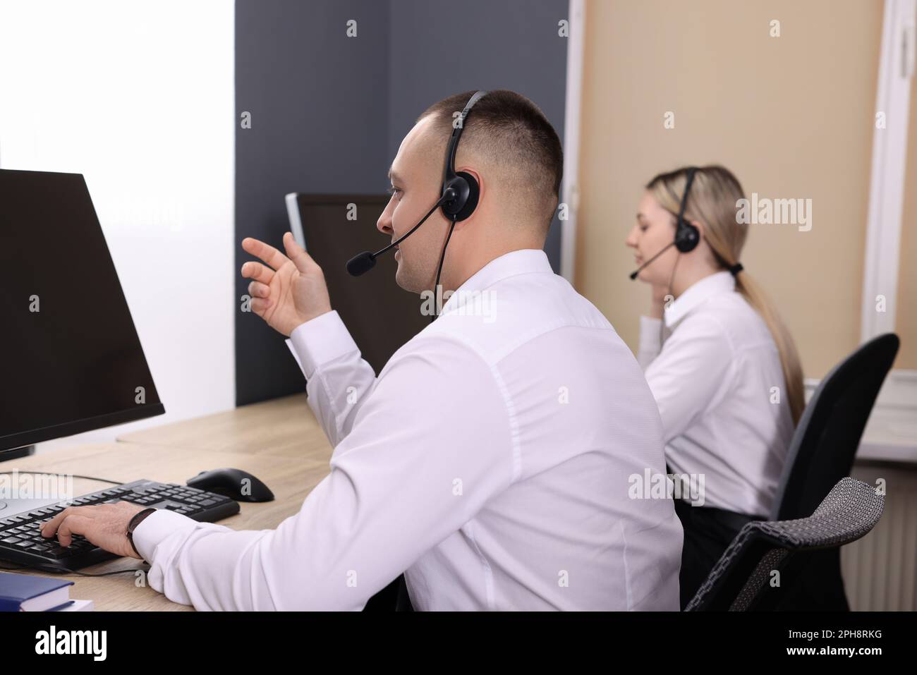 Call center operators working in modern office Stock Photo - Alamy
