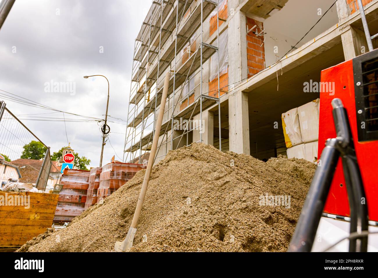 Big hill of gravel with vertical stuck digging tool shovel, in the ...