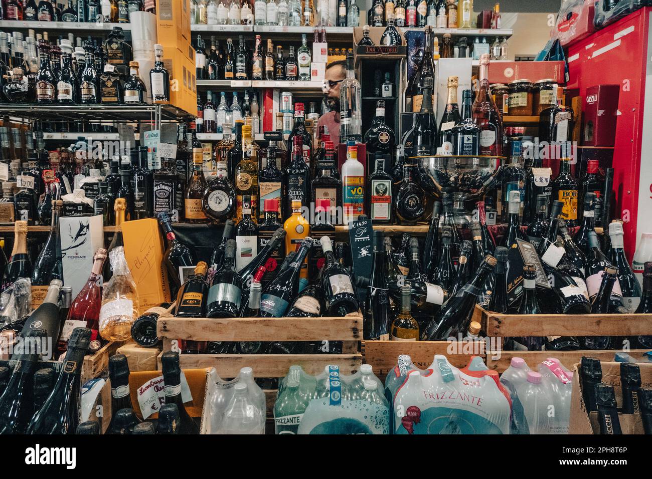 Bottles of alcoholic beverages on display in a shop. Wine, gin ...